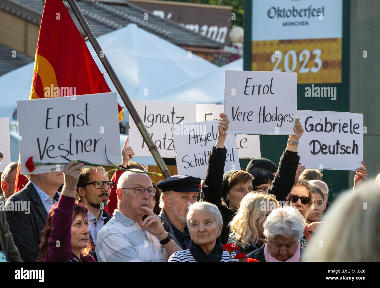 Munich, Germany. 26th Sep, 2023. Relatives hold up signs with the names ...