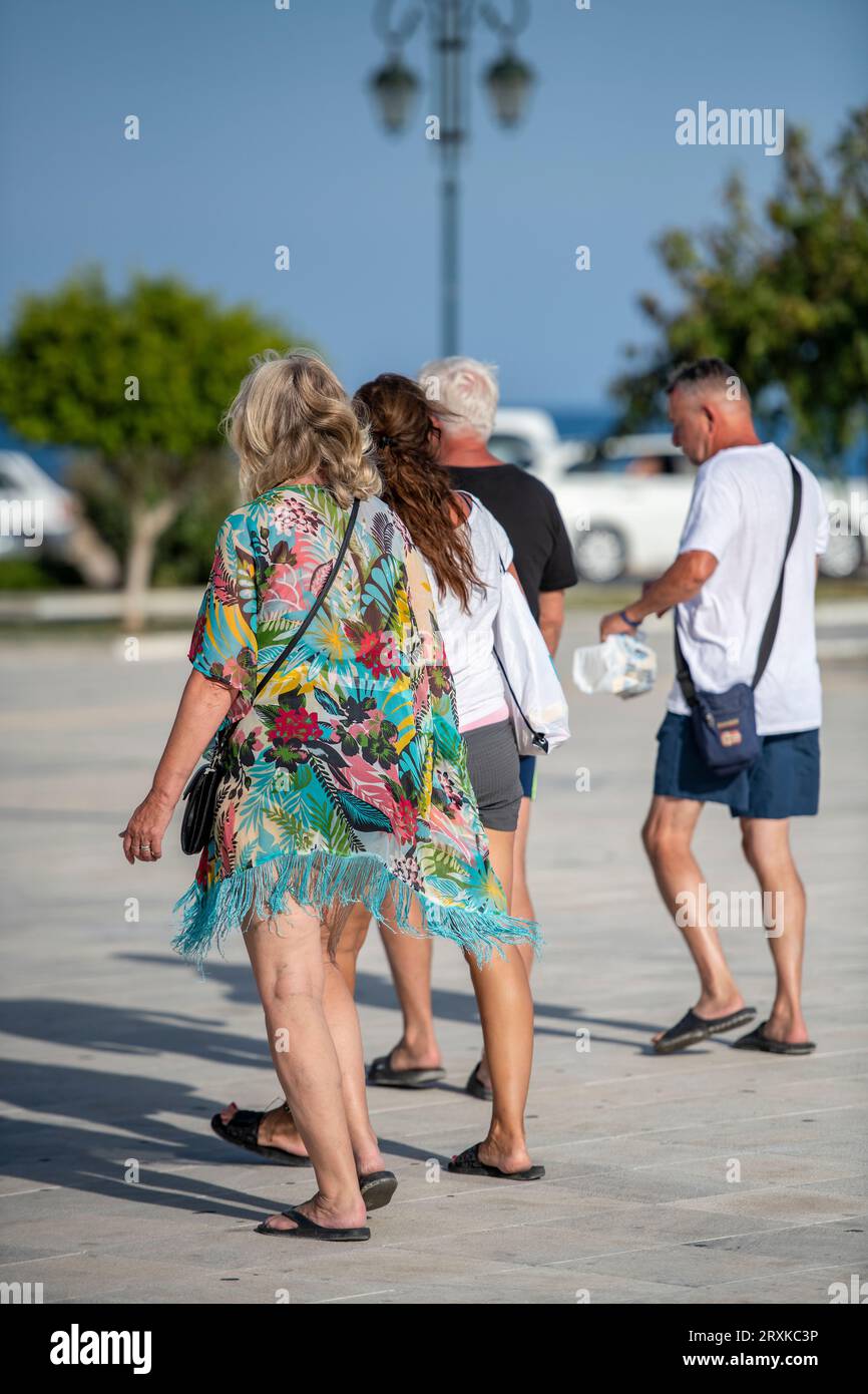 two couples walking across solomos square in zante or zakynthos town in ...