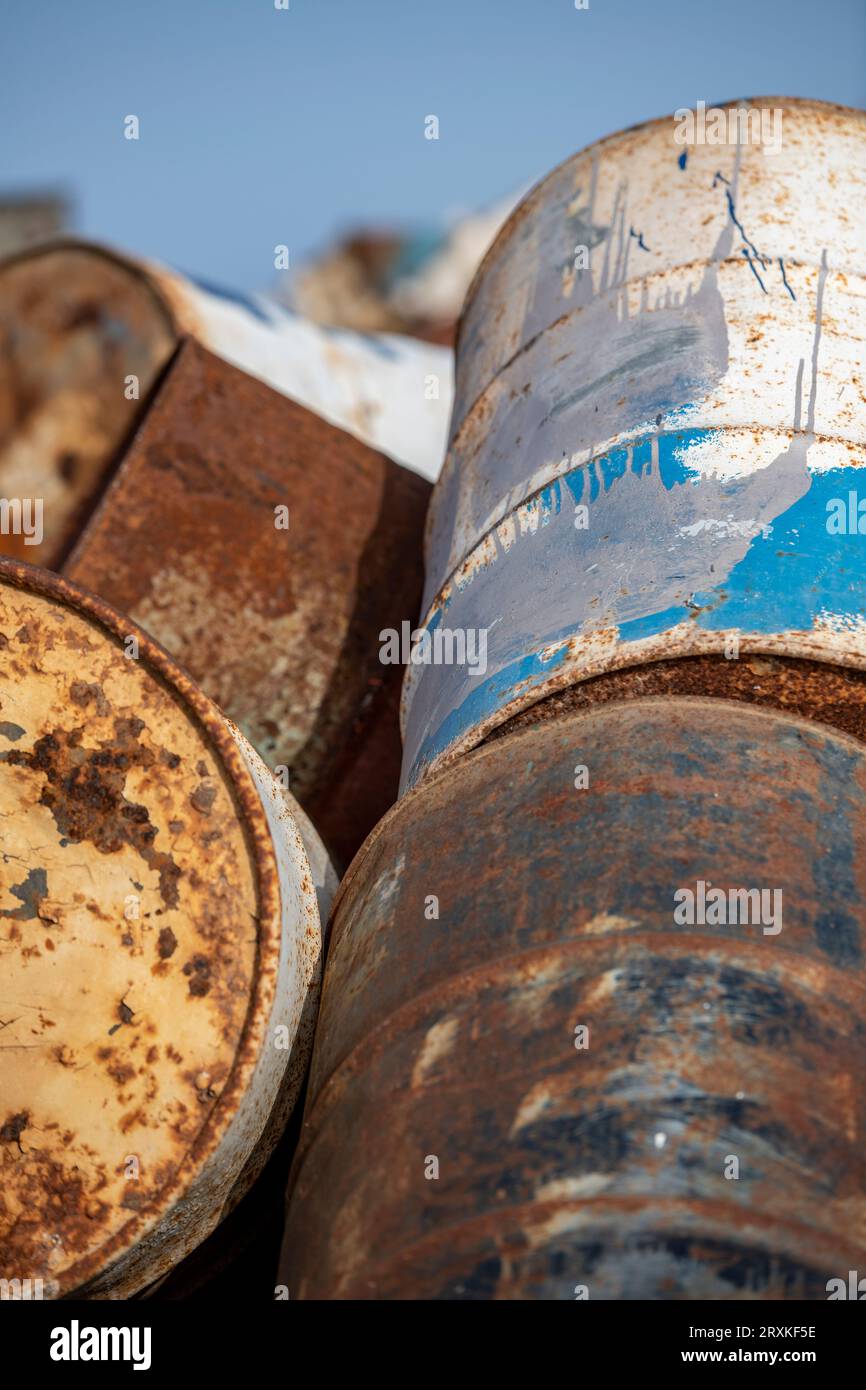 pile of scrap metal oil drums ready for recycling at a metal scrapyard ...