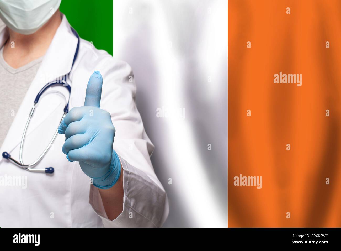 Irish doctor's hand showing thumb up positive gesture on flag of ...