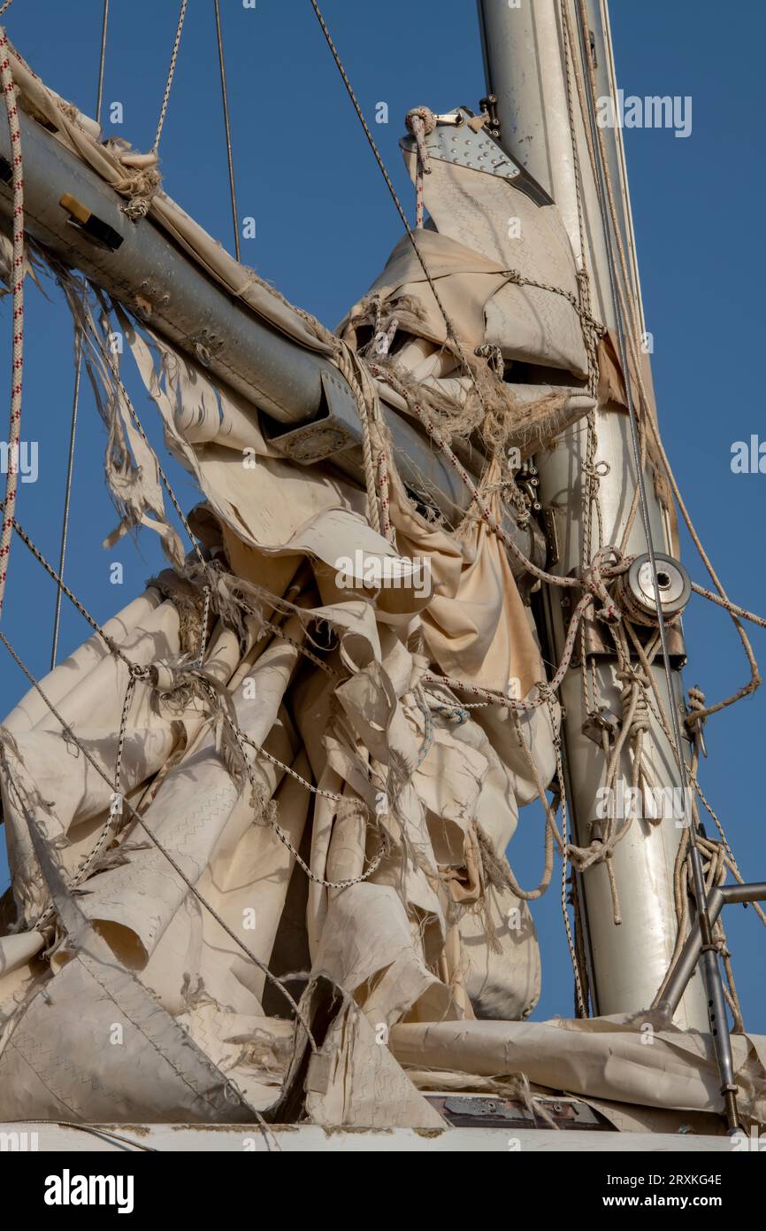 sails battered by the waves and weather hanging in shreds from the mast ...