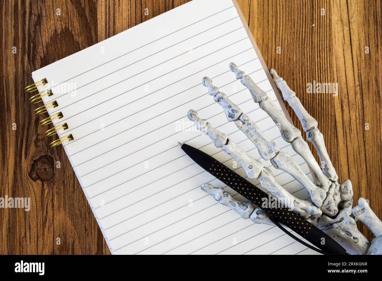 Skeleton hand with pencil hi-res stock photography and images - Alamy