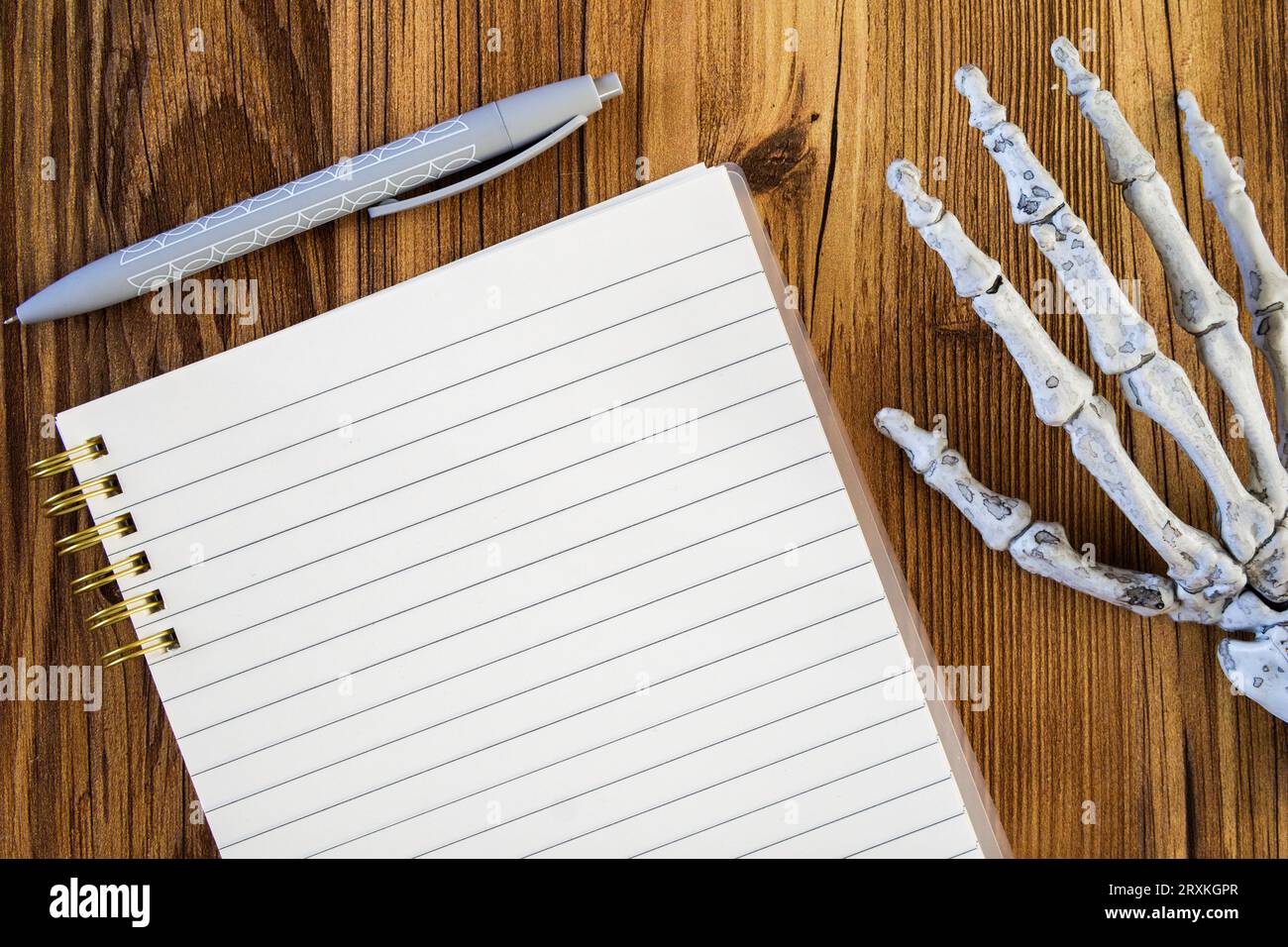 Skeleton hand with pencil hi-res stock photography and images - Alamy