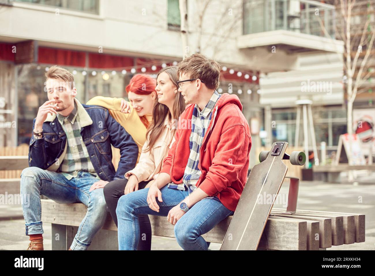 Teenage friends sitting together Stock Photo - Alamy