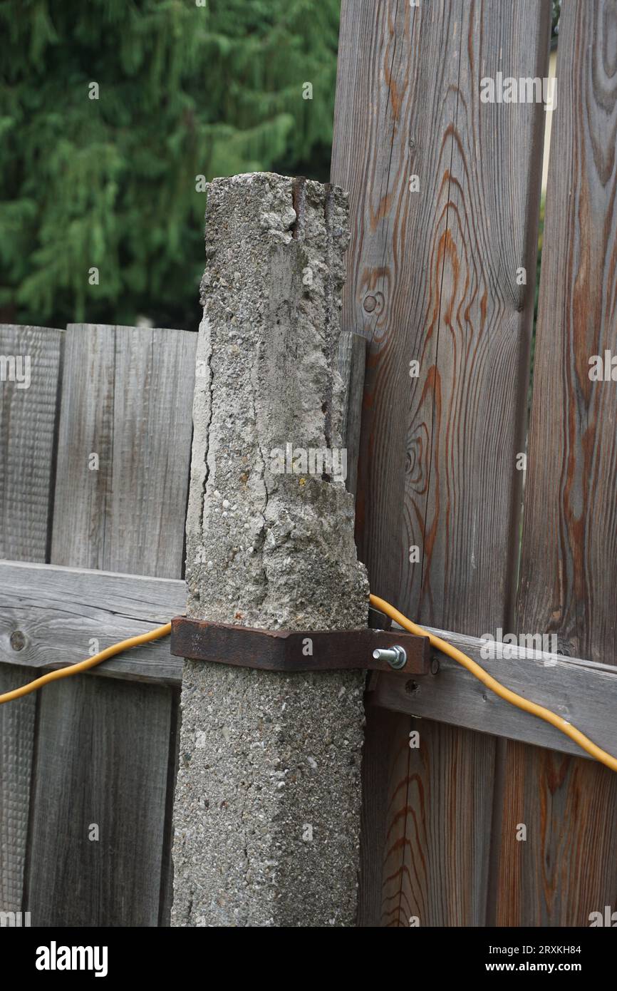 Fence post made of concrete with cable Stock Photo - Alamy