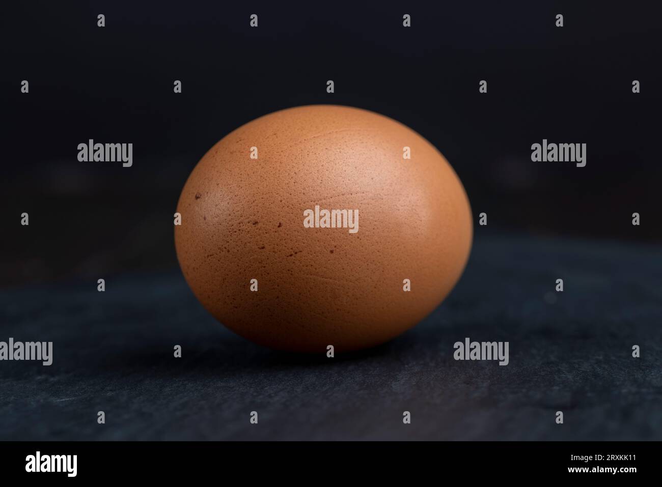 A clean whole orange chicken egg close-up on the table, a large chicken ...