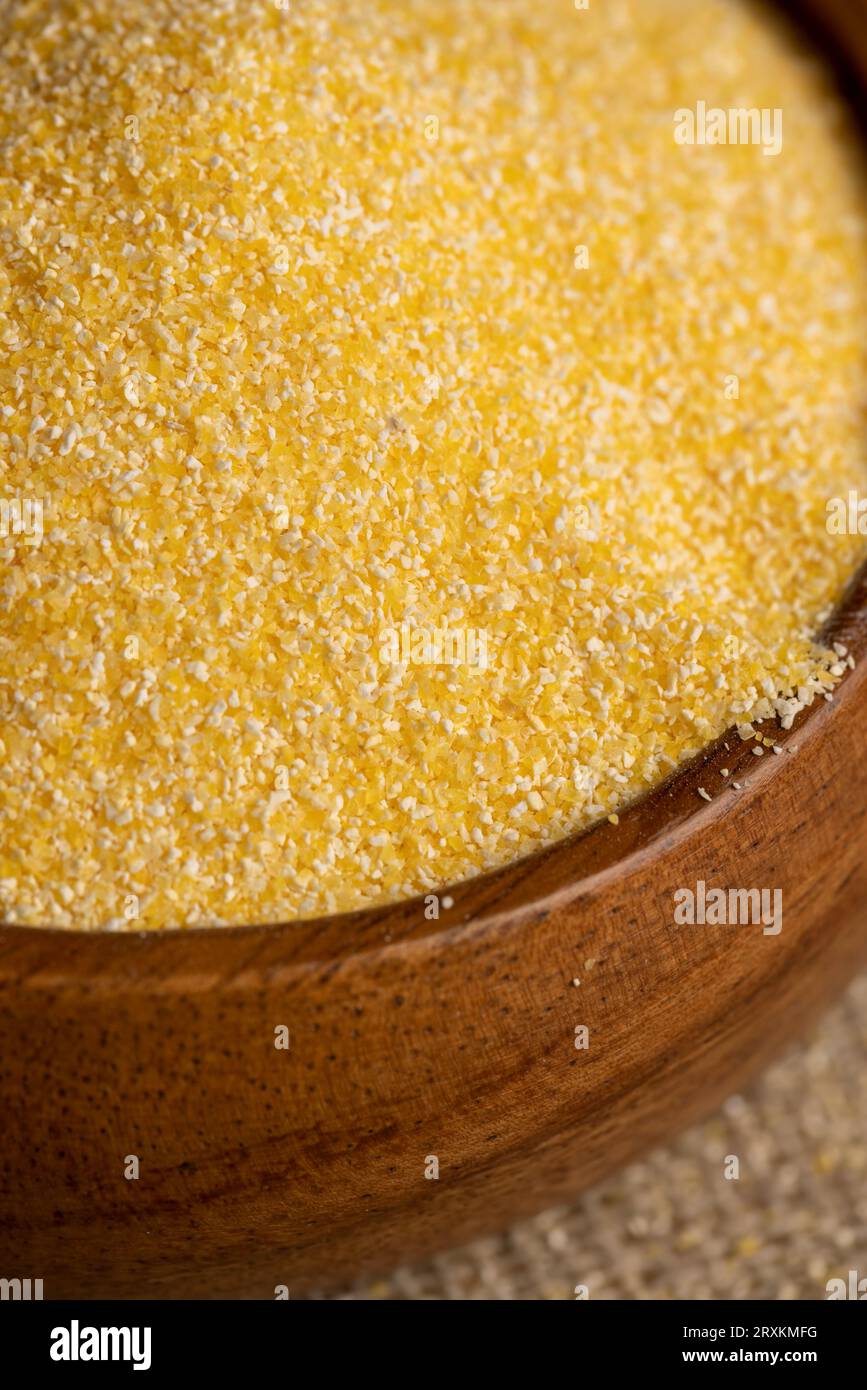 Round wooden bowl with dry corn flour for cooking porridge, high ...