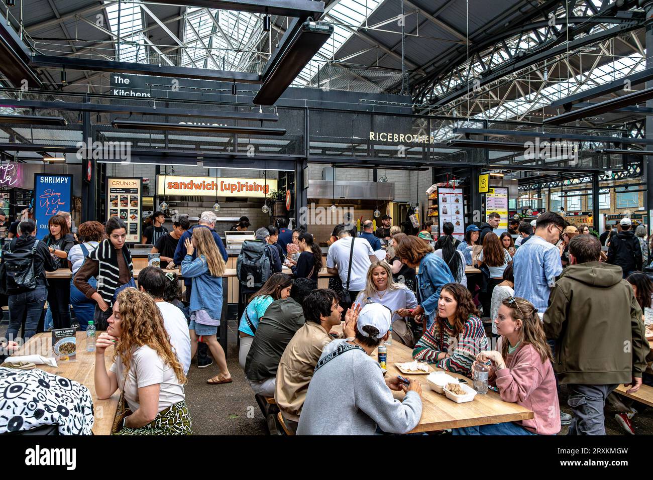 People enjoying food from various food vendors at the food hall in Old ...