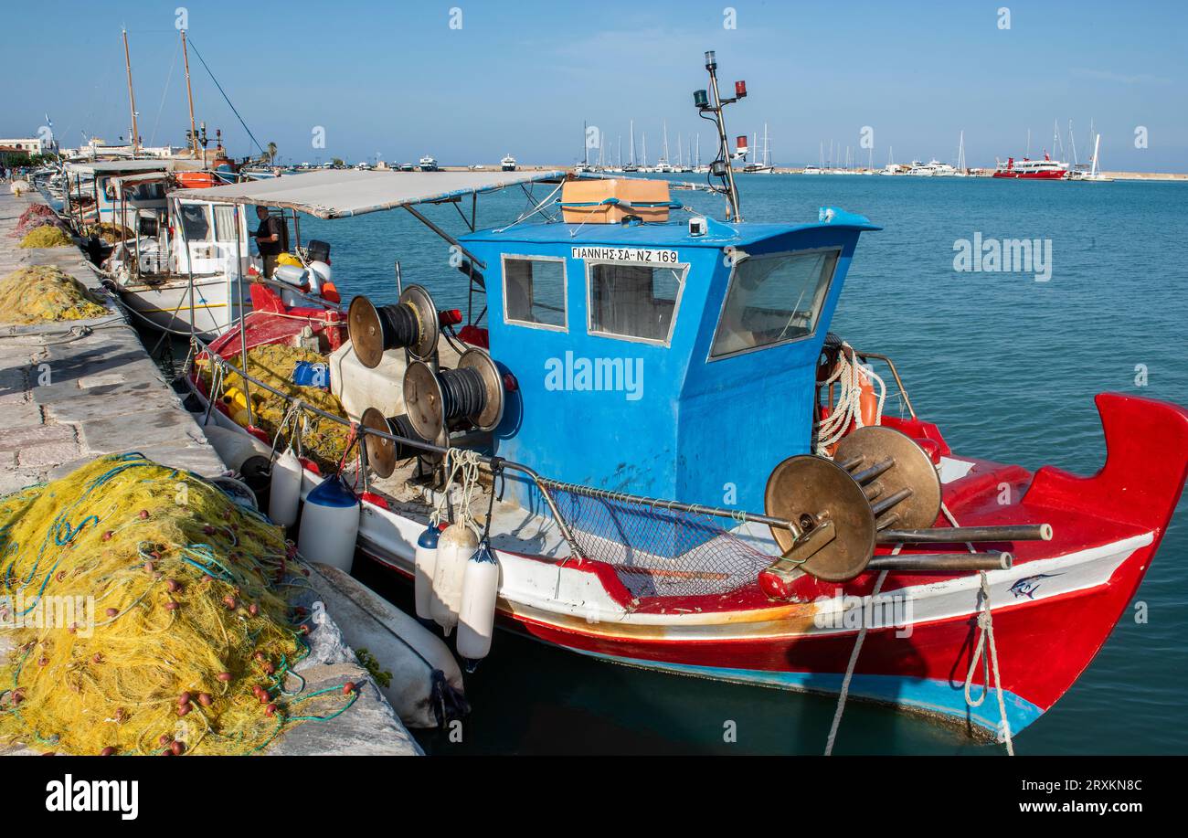 traditional greek wooden fishing boats alongside in the harbour or port ...