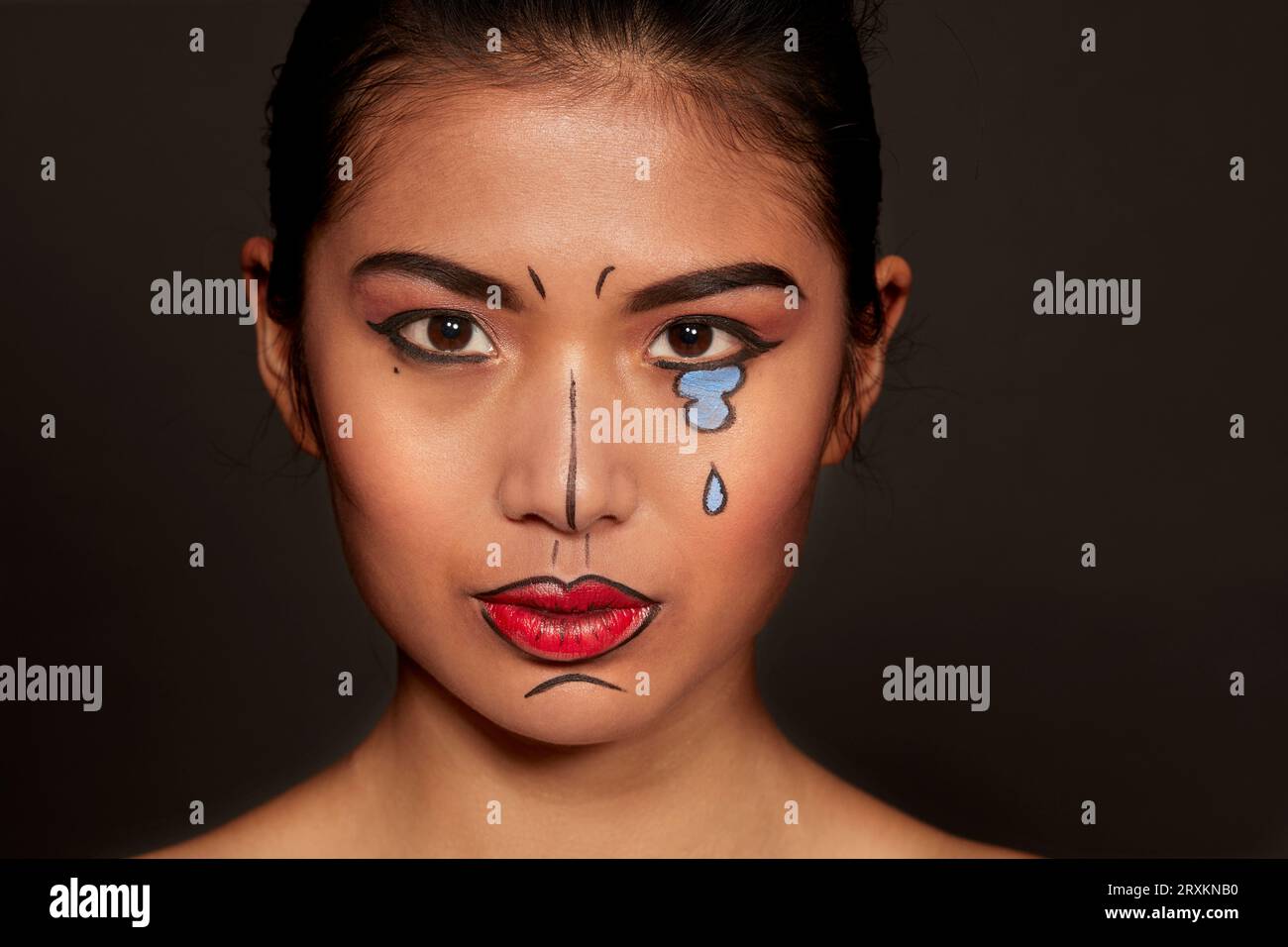 Young woman with face paint tears and lines Stock Photo - Alamy