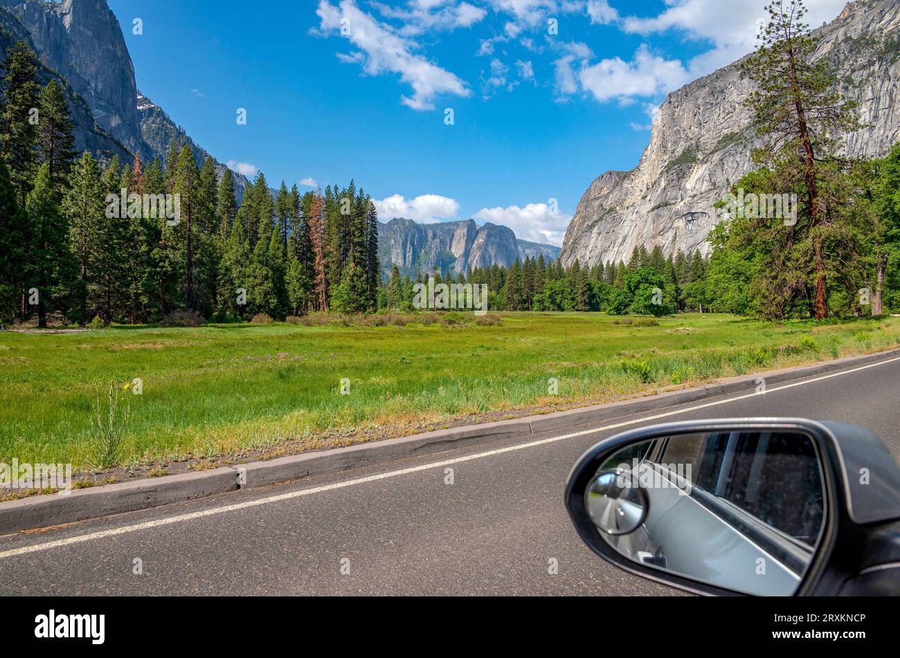 Scenic view of Yosemite Valley with car side-view mirror in foreground ...
