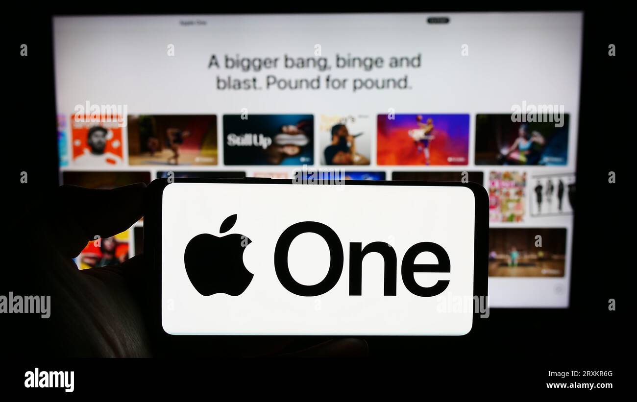 Person holding mobile phone with logo of subscription service Apple One ...