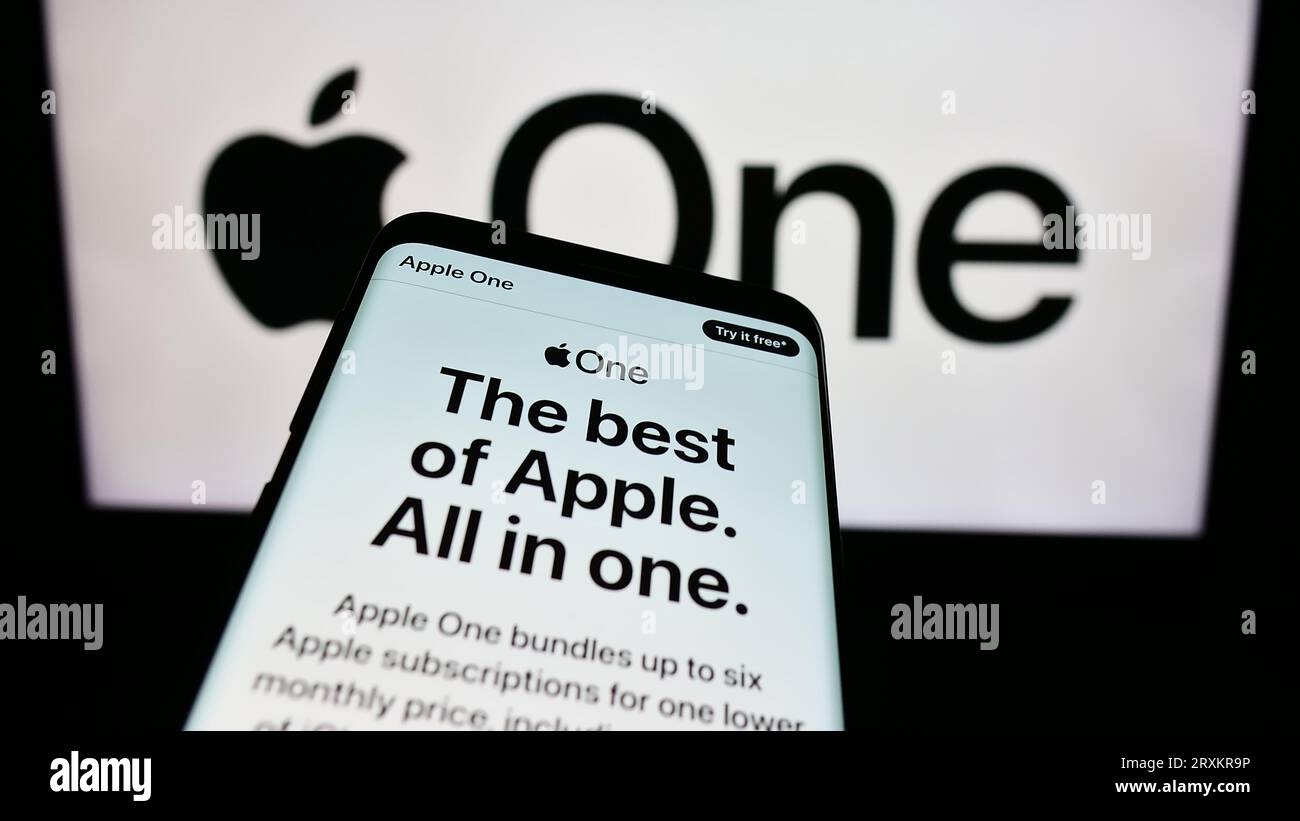 Mobile phone with website of subscription service Apple One on screen ...