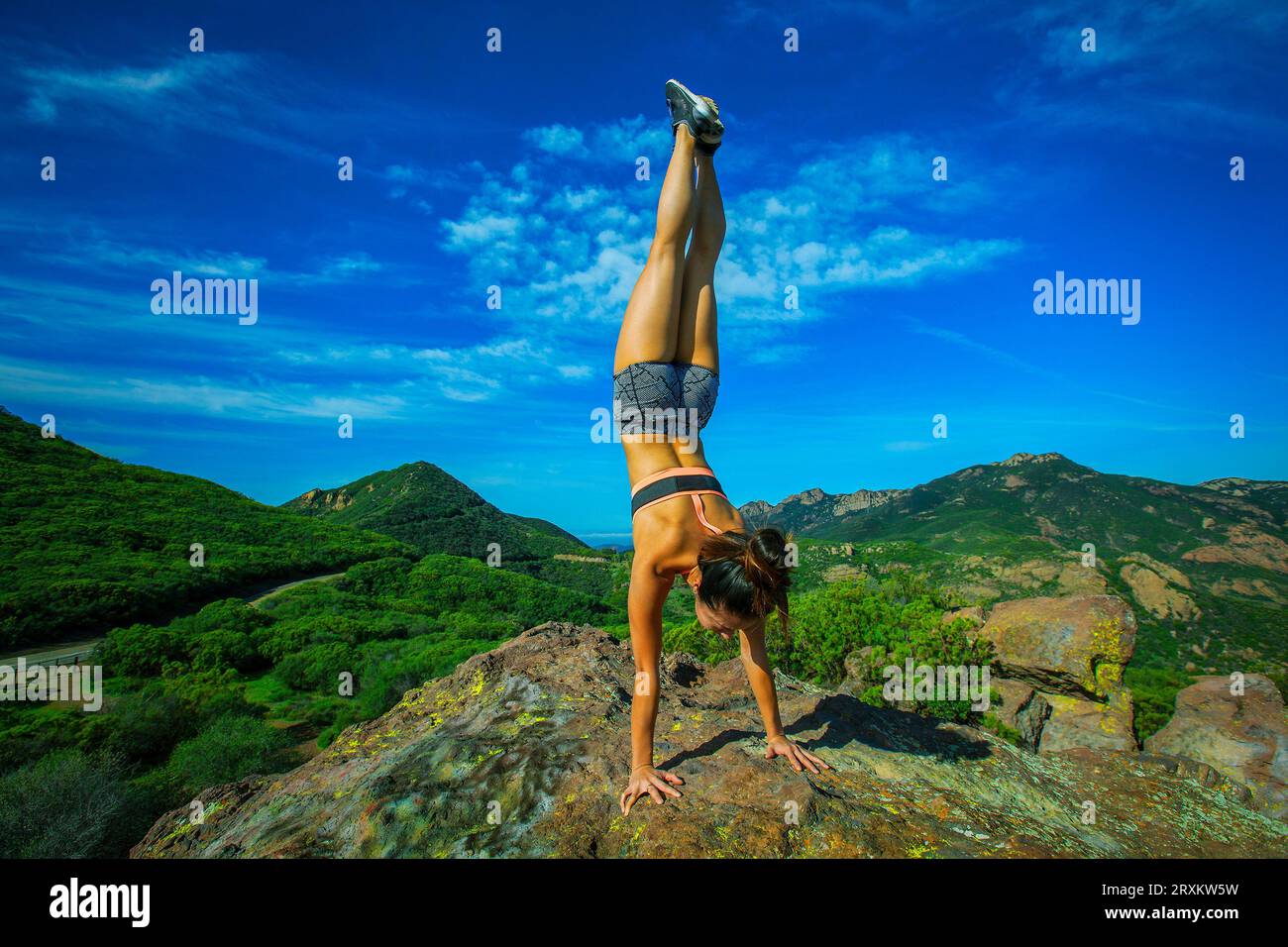 Young woman doing handstand hi-res stock photography and images - Alamy