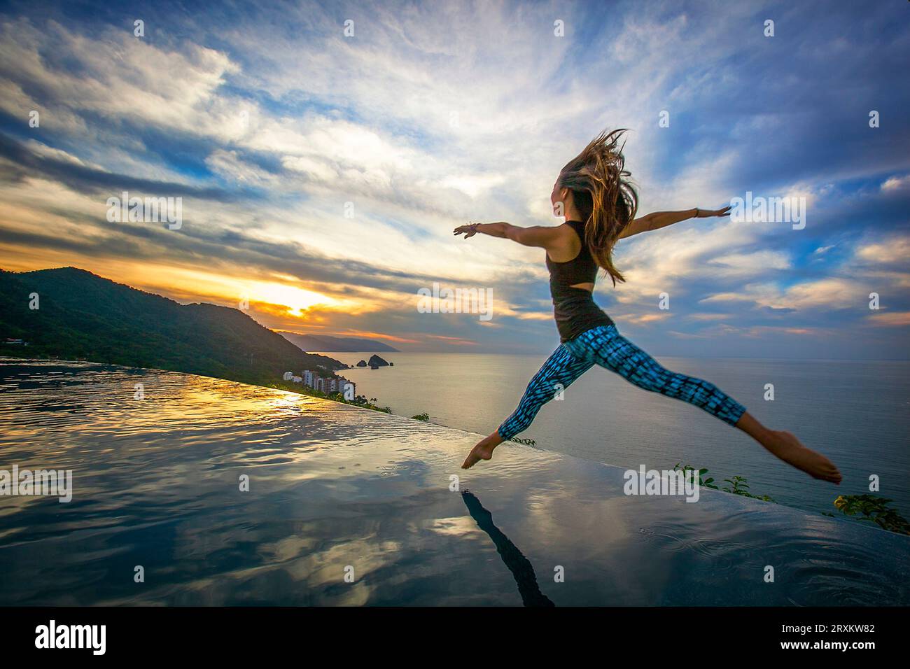Woman infinity pool sunset hi-res stock photography and images - Alamy