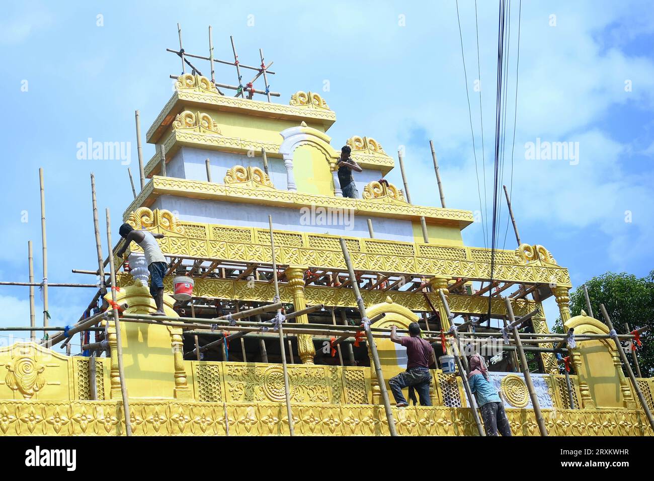 Workers are making a pandal, a temporary structure set up to usually ...
