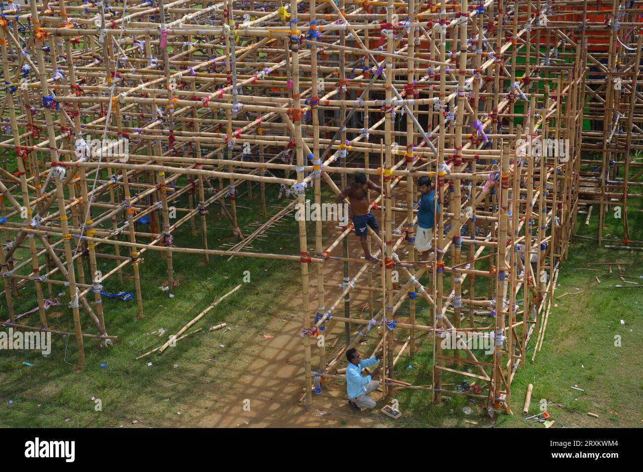 Workers are making a temporary bamboo structure, locally called "Pandal ...