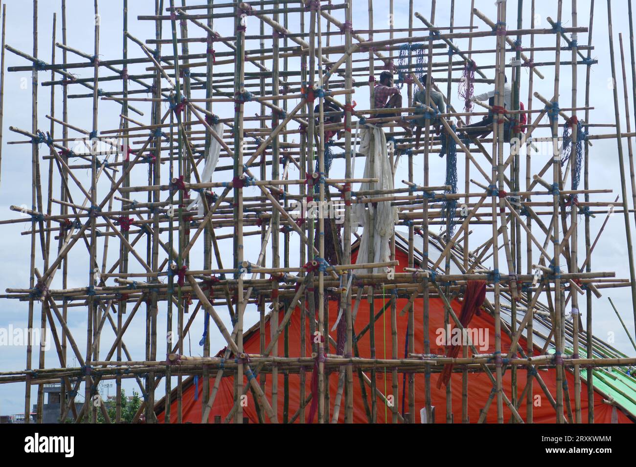 Workers are making a temporary bamboo structure, locally called "Pandal ...