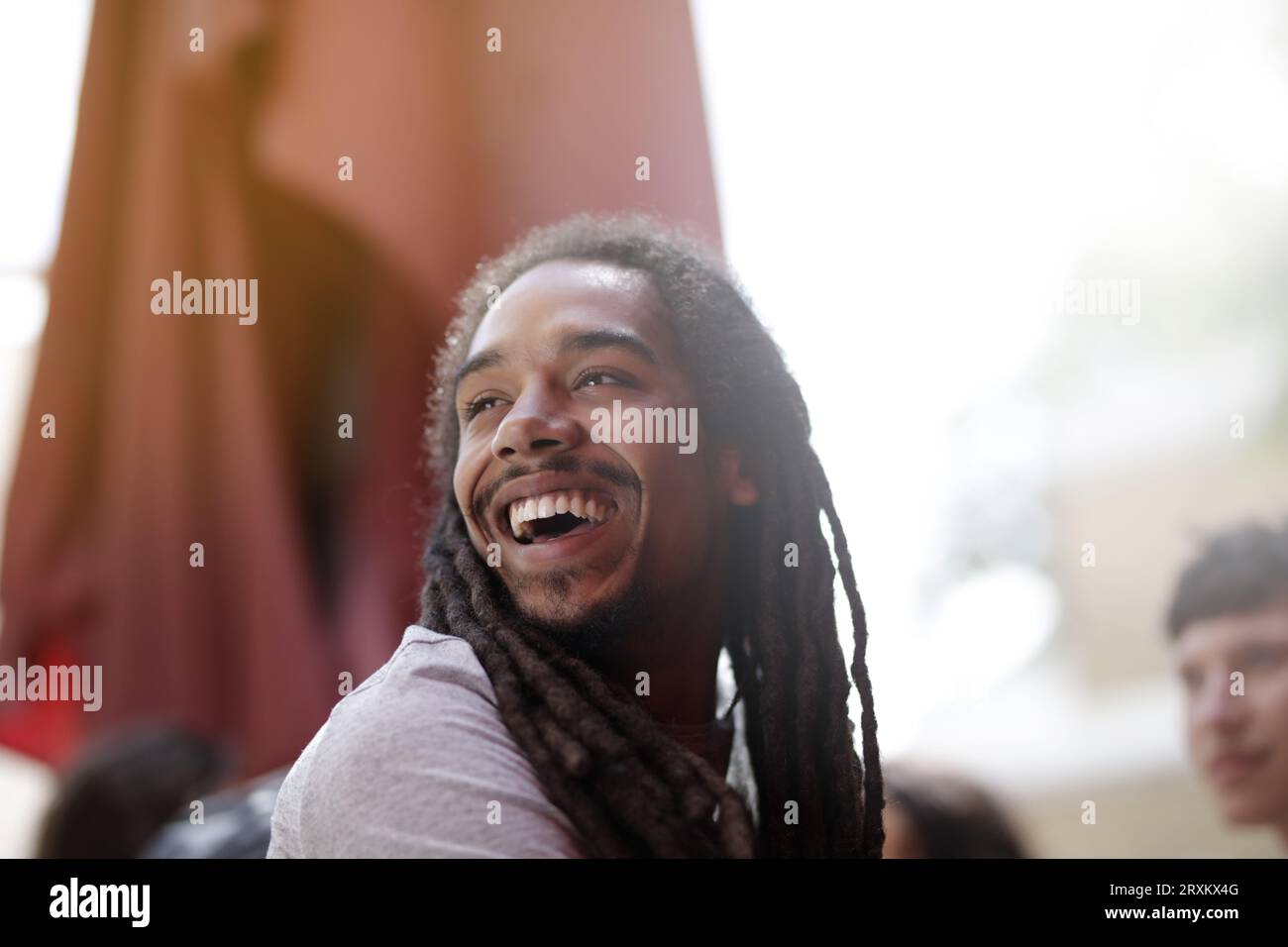 Man smiling with dreadlocks Stock Photo - Alamy