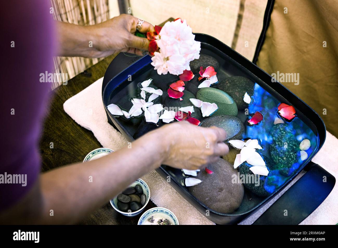 Woman's hands putting flowers on tray Stock Photo - Alamy