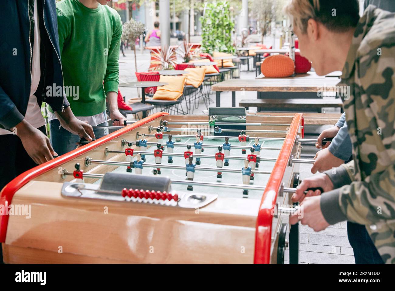 Teenage boys playing table football Stock Photo - Alamy