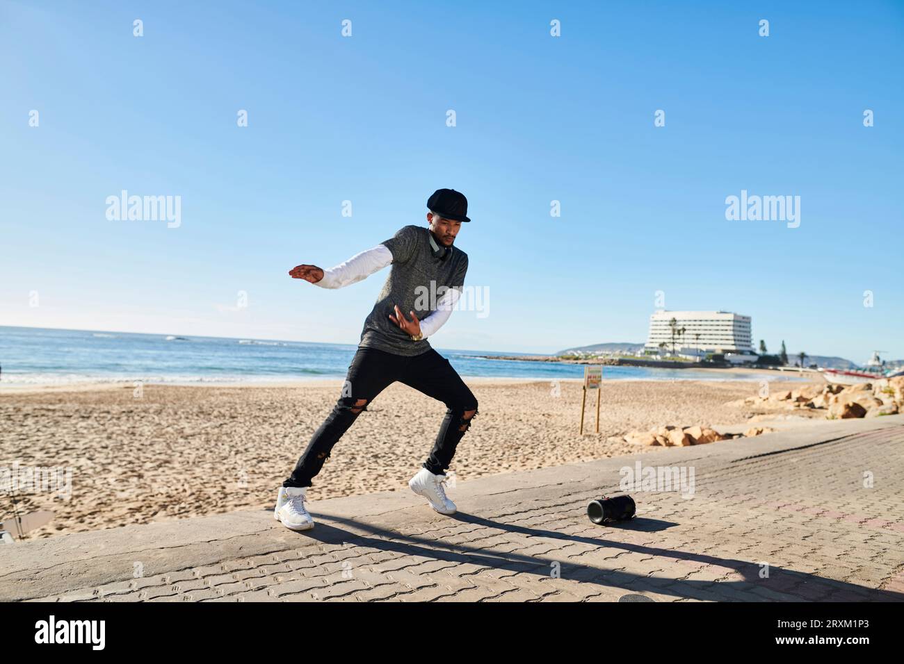 Young man break dancing by beach Stock Photo - Alamy