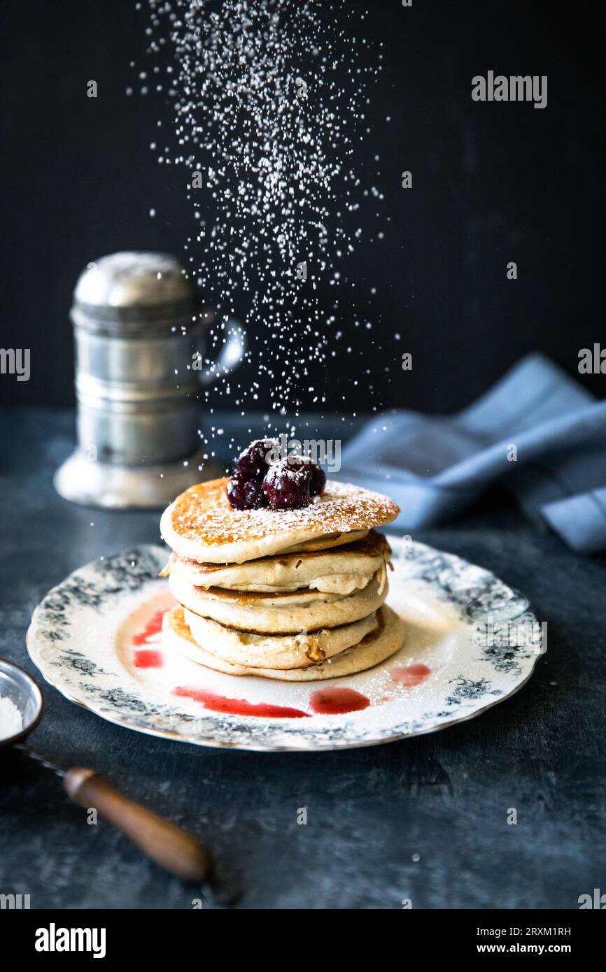 Pancake stack with cherries and icing sugar Stock Photo - Alamy
