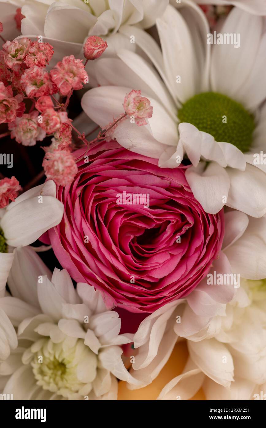 using different types of flowers to create a small bouquet for a ...