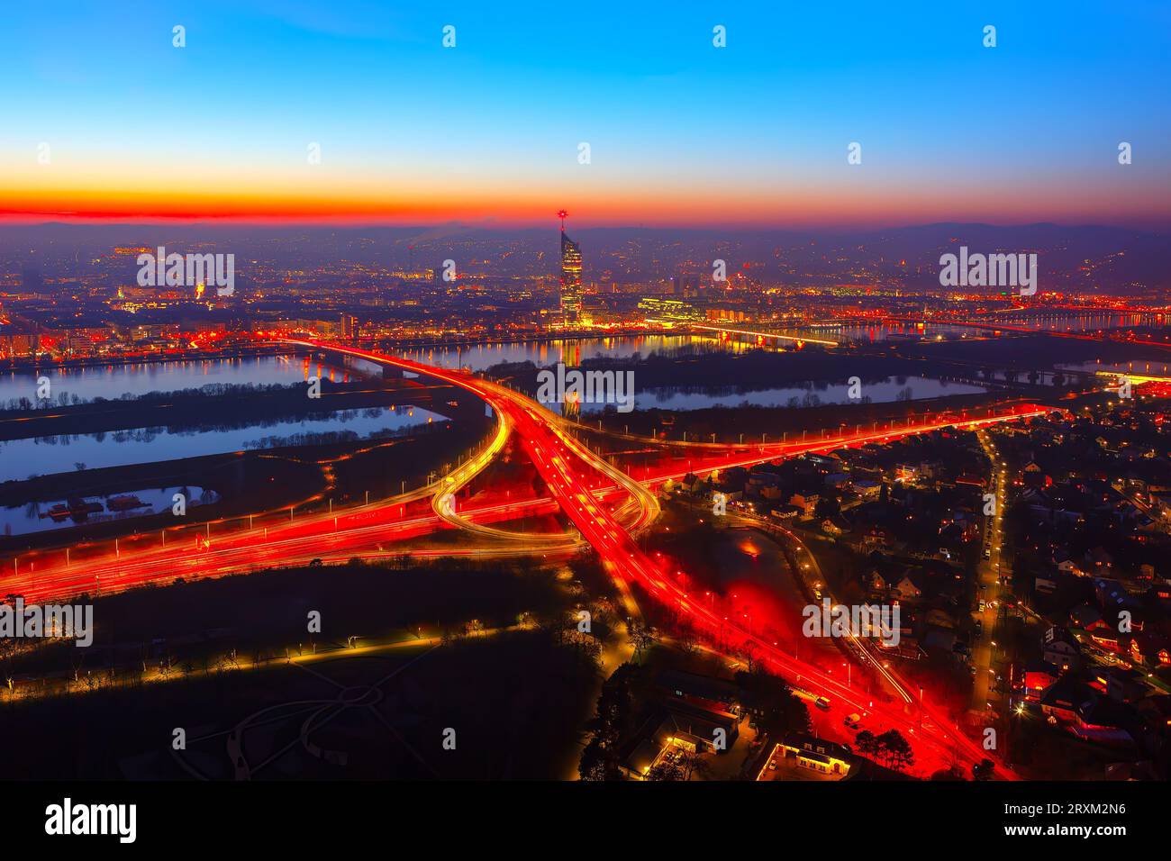 Modern European city illuminated in the night . Aerial view of Vienna ...