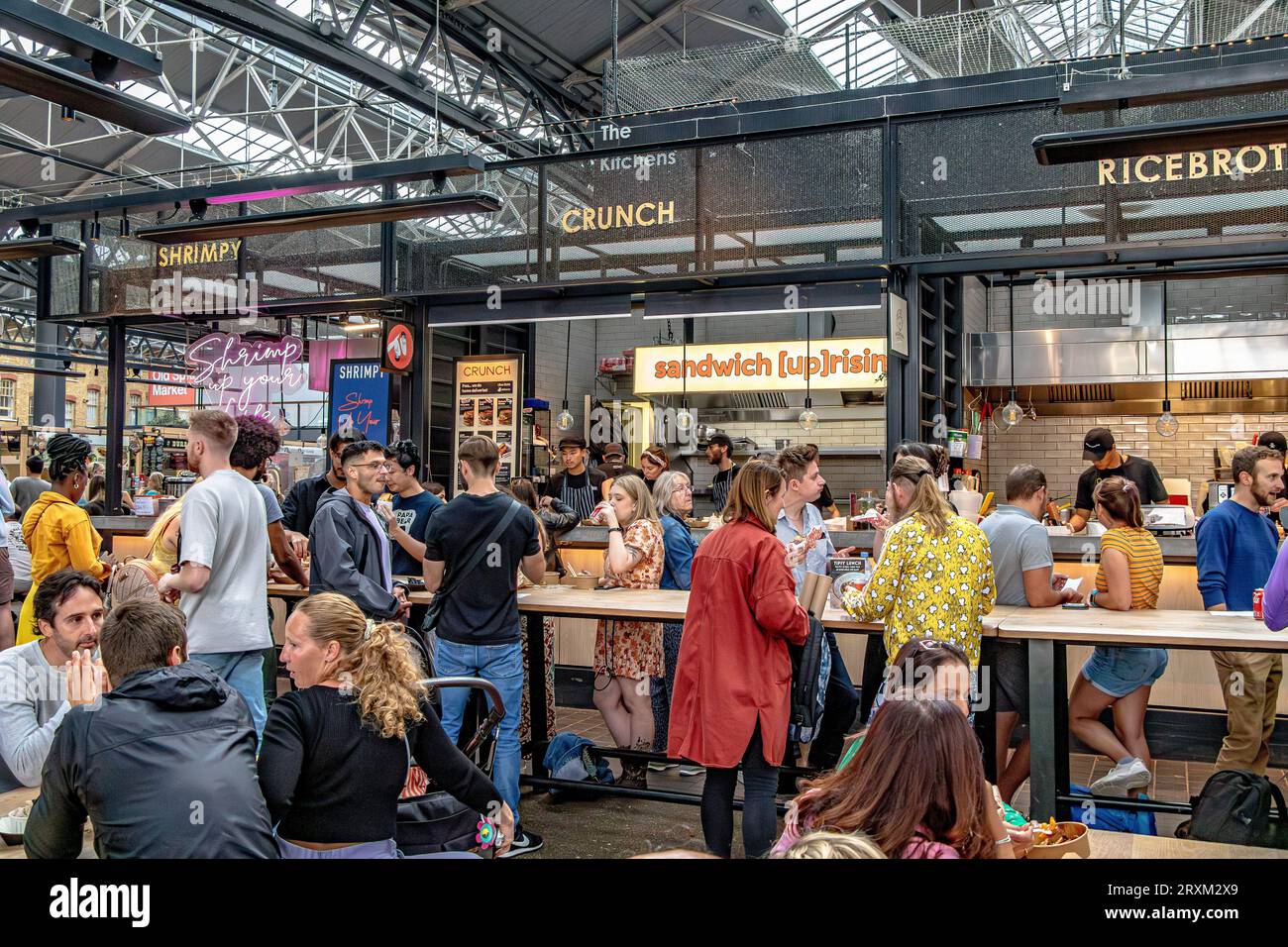 People enjoying food from various food vendors at the food hall in Old ...