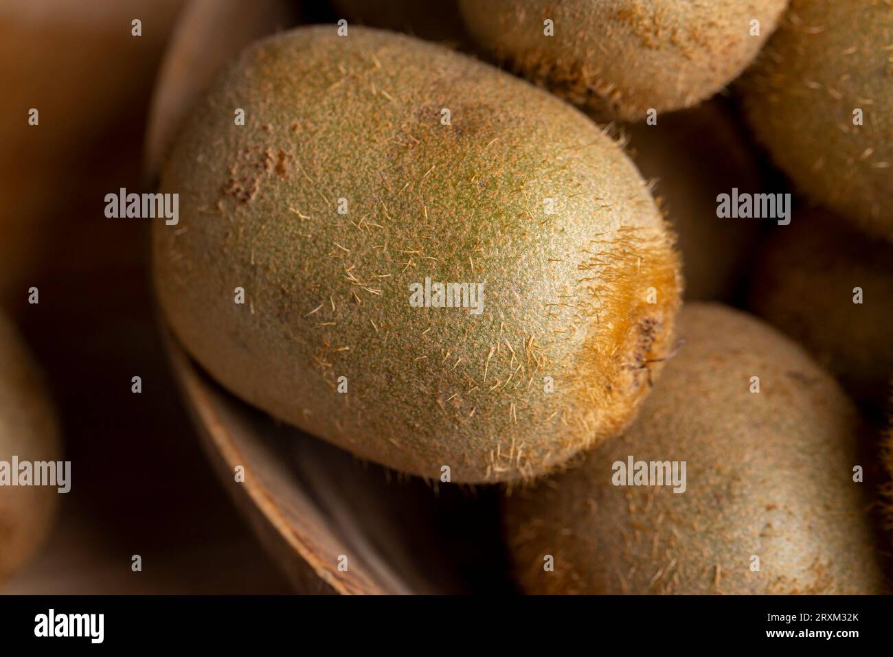 A group of whole green kiwi fruits not peeled, whole kiwis pile in a ...