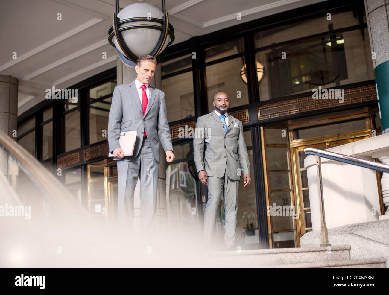 Businessmen wearing suits outside building Stock Photo - Alamy