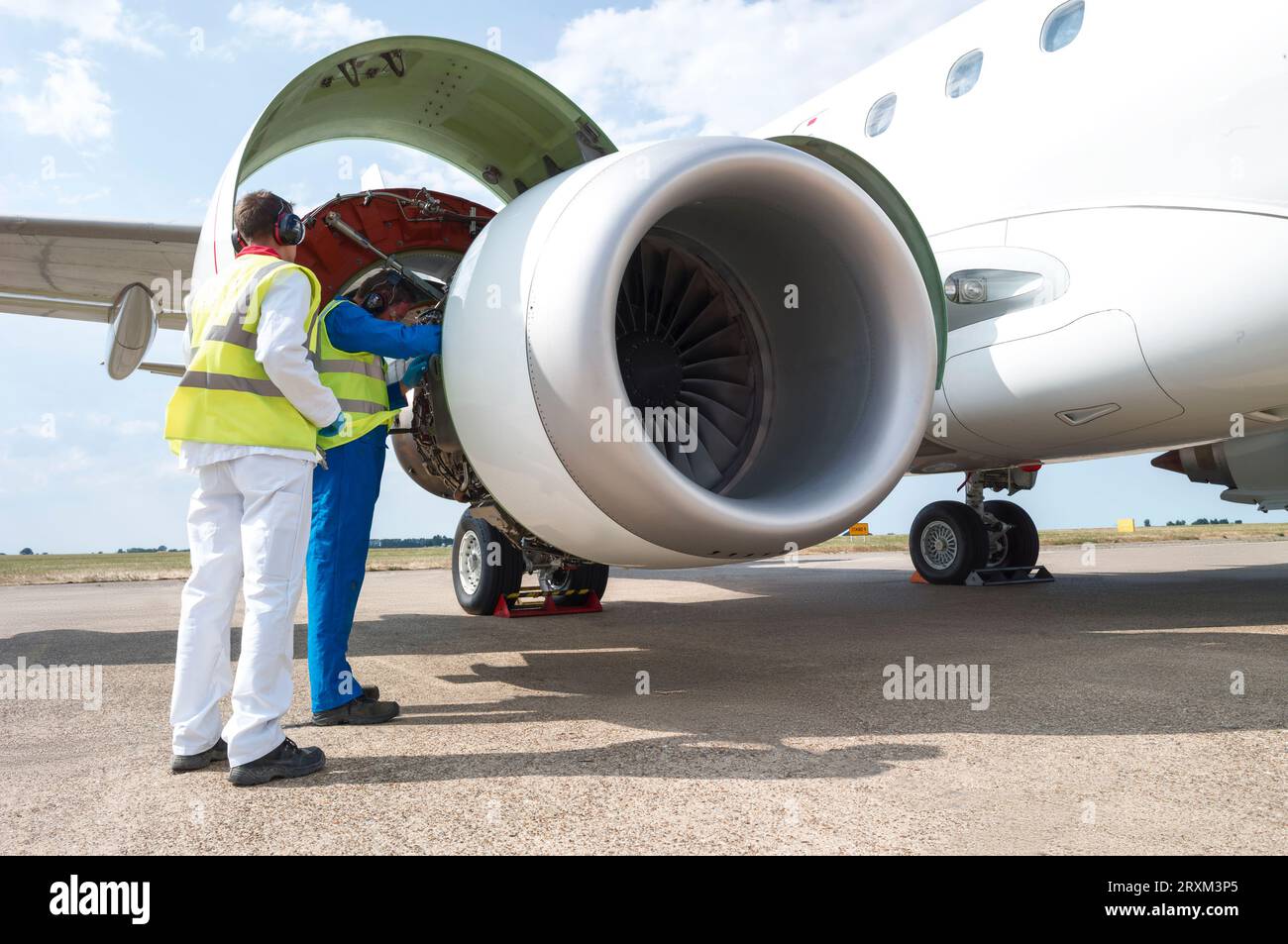 Men working on airplane engine Stock Photo - Alamy
