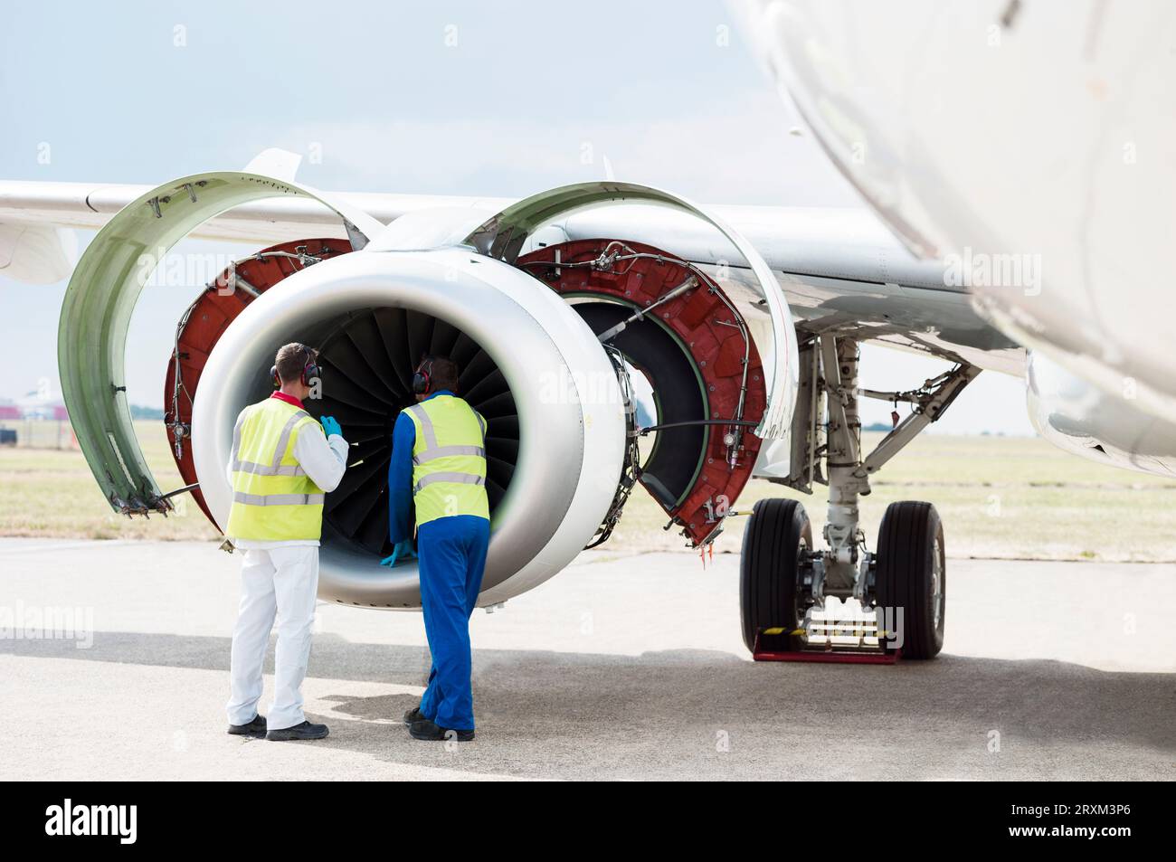 Men working on airplane engine Stock Photo - Alamy