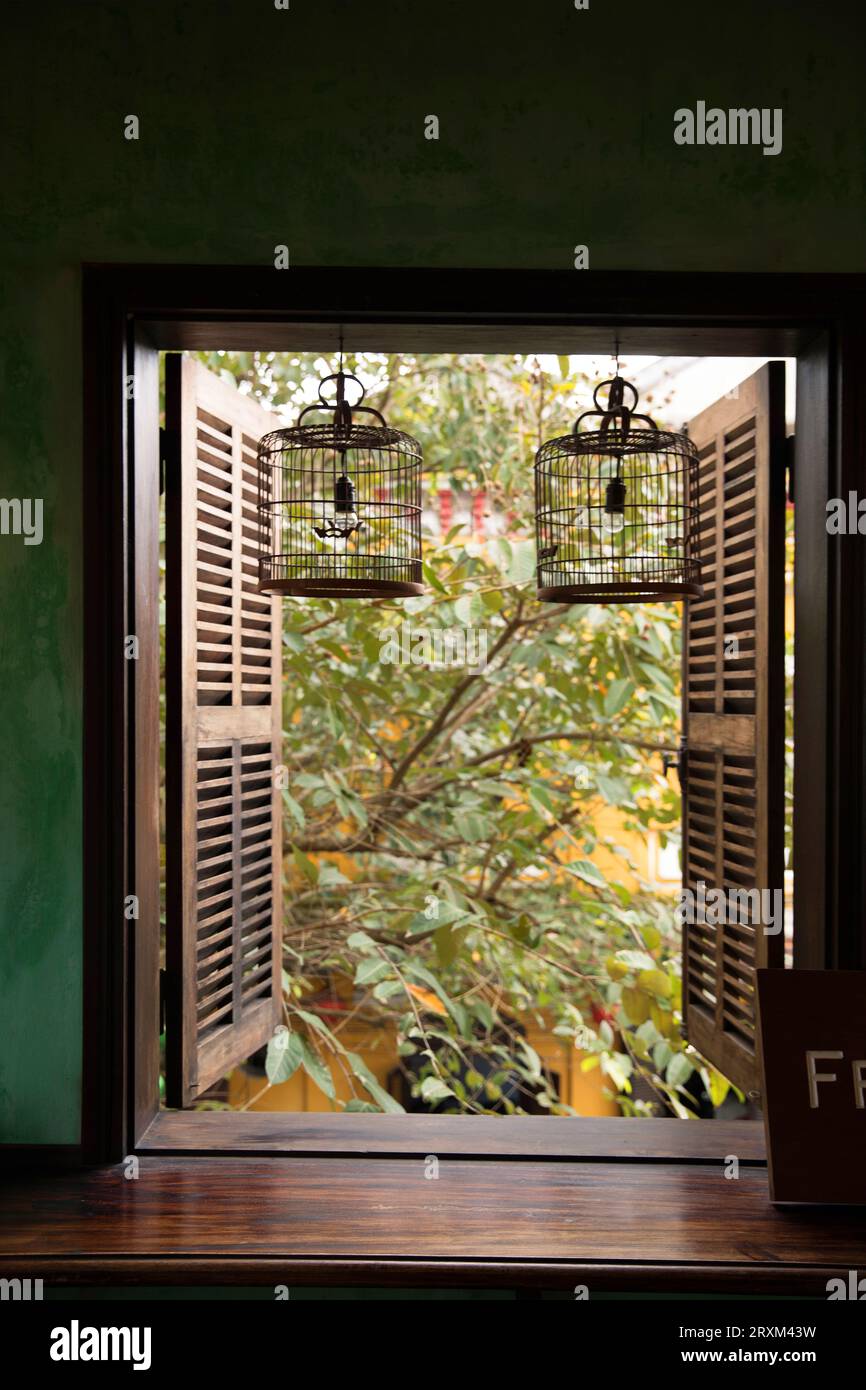 Lights in window with open shutters Stock Photo - Alamy