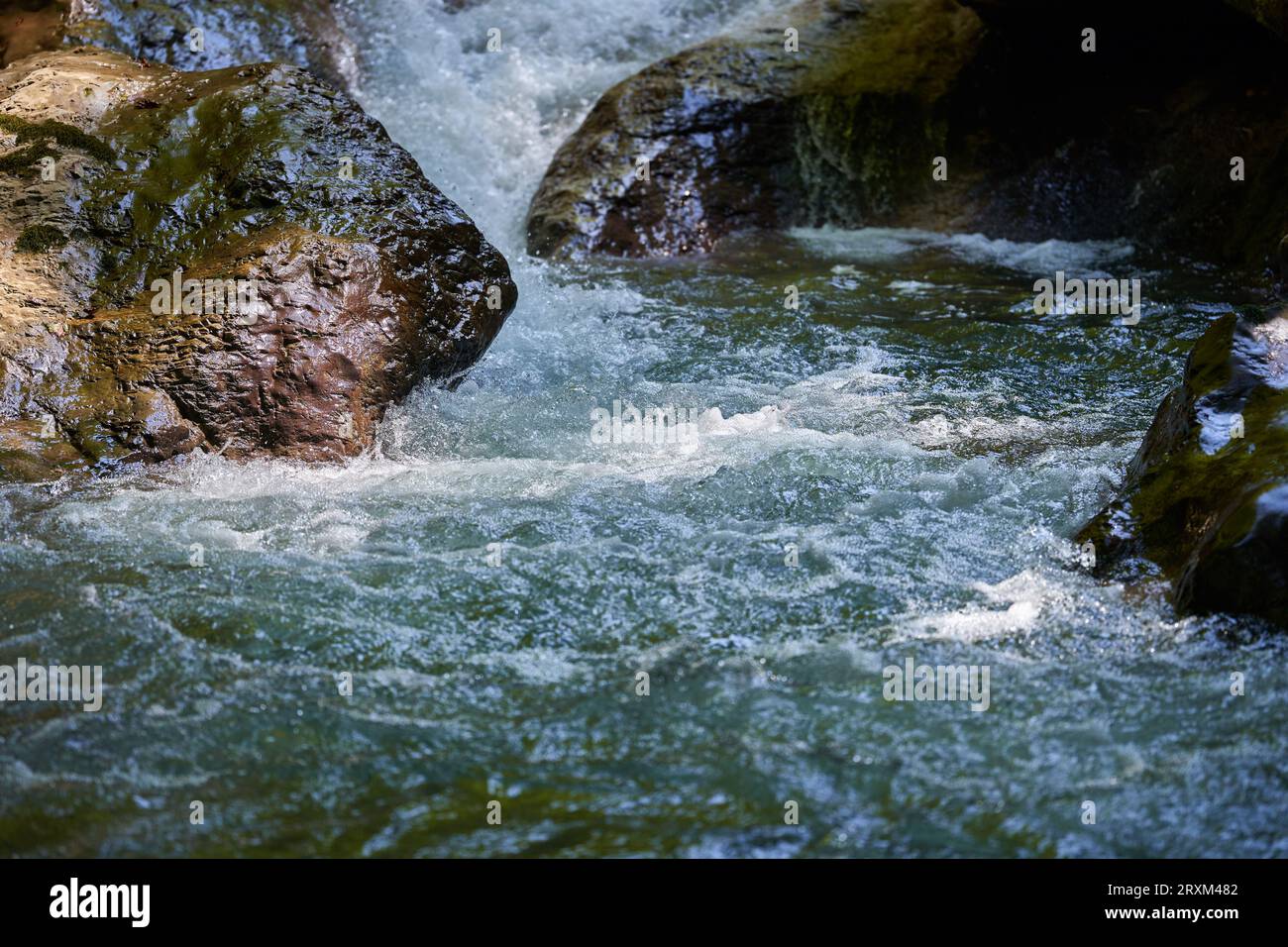 Mountain river with rapids and pristine azure water flowing fast among ...