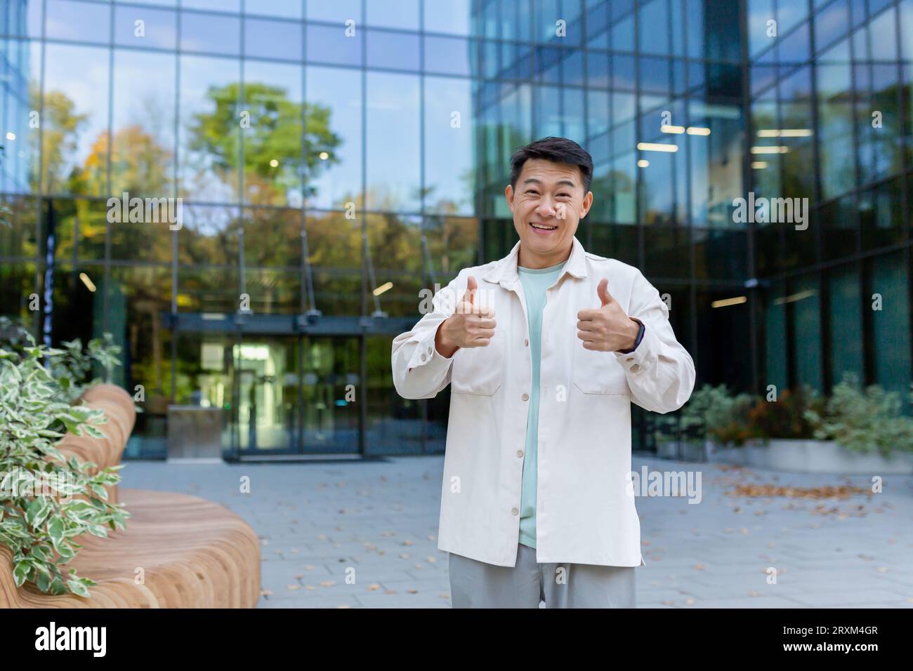 Asian businessman, founder of a firm and company standing in front of ...