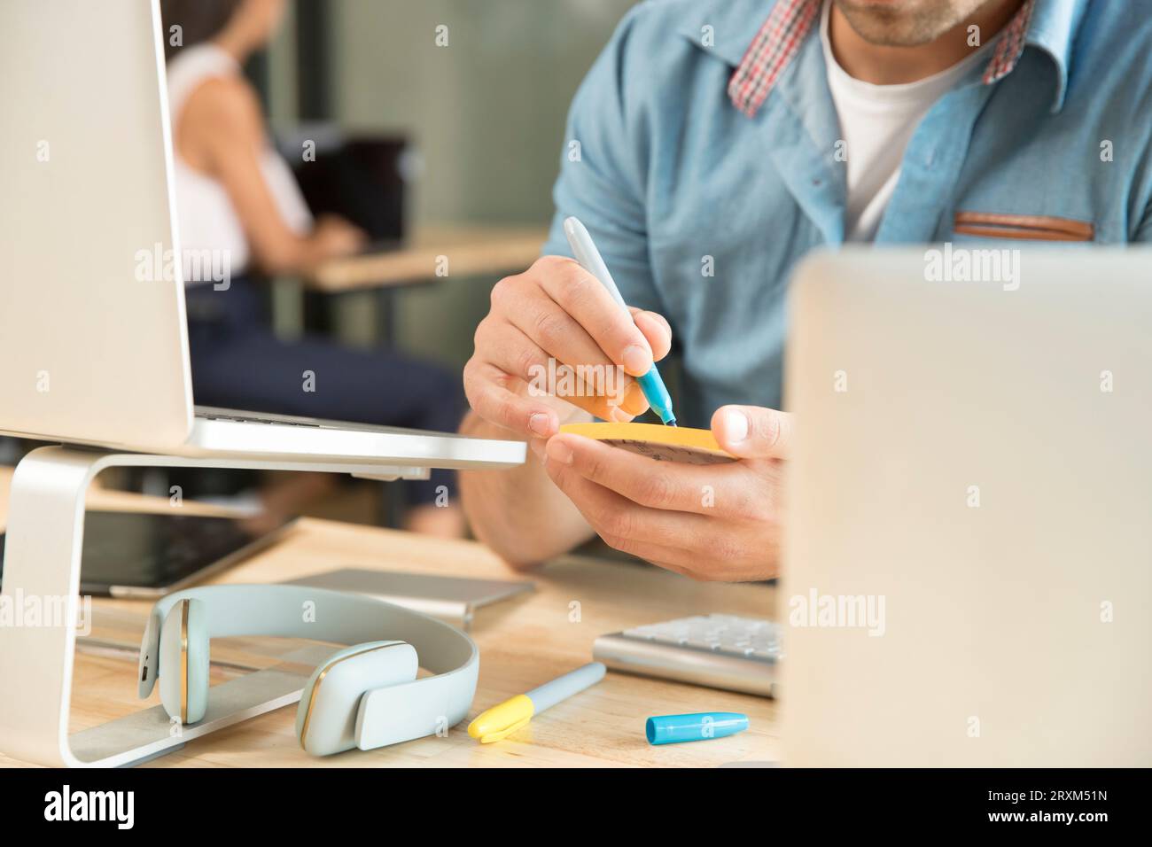 Young man sit desk hold hi-res stock photography and images - Alamy
