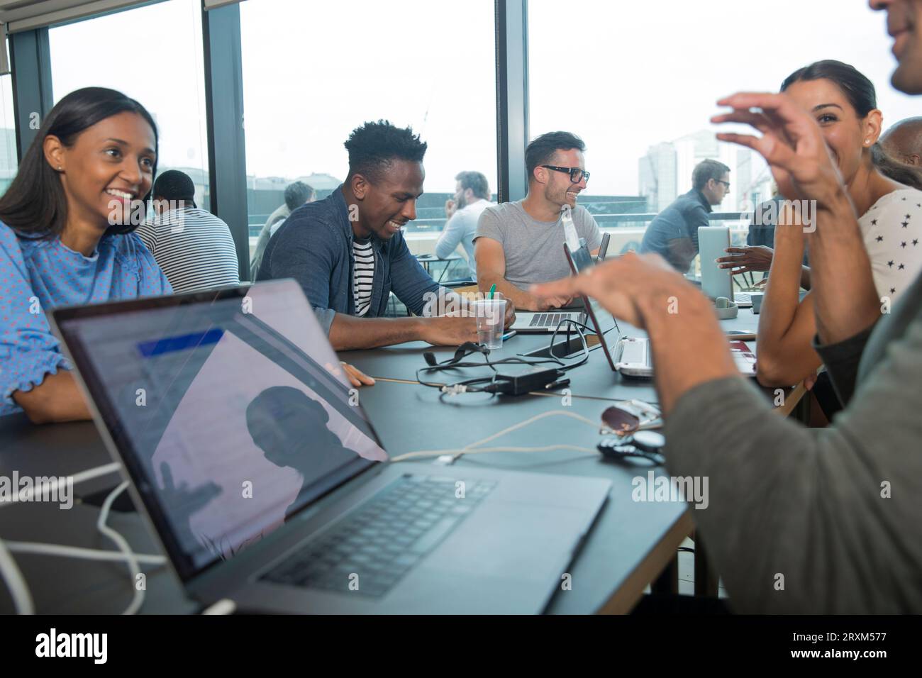 Colleagues using laptops during meeting Stock Photo - Alamy