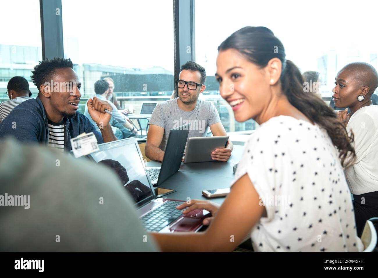 Colleagues using laptops during meeting Stock Photo - Alamy