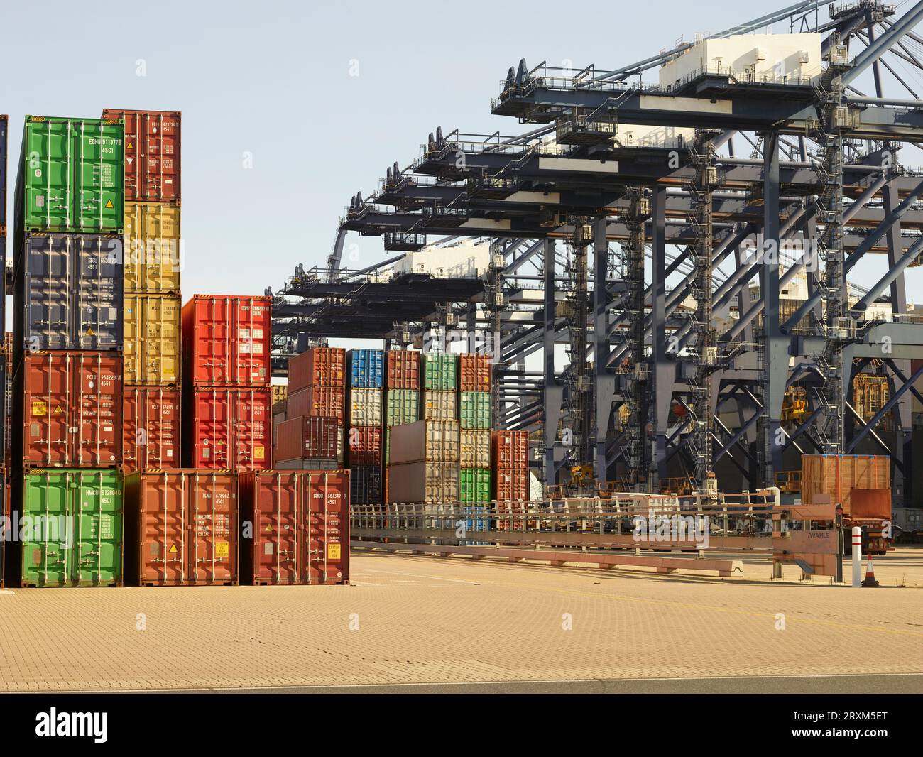Stack of cargo containers and cranes at Port of Felixstowe, England ...