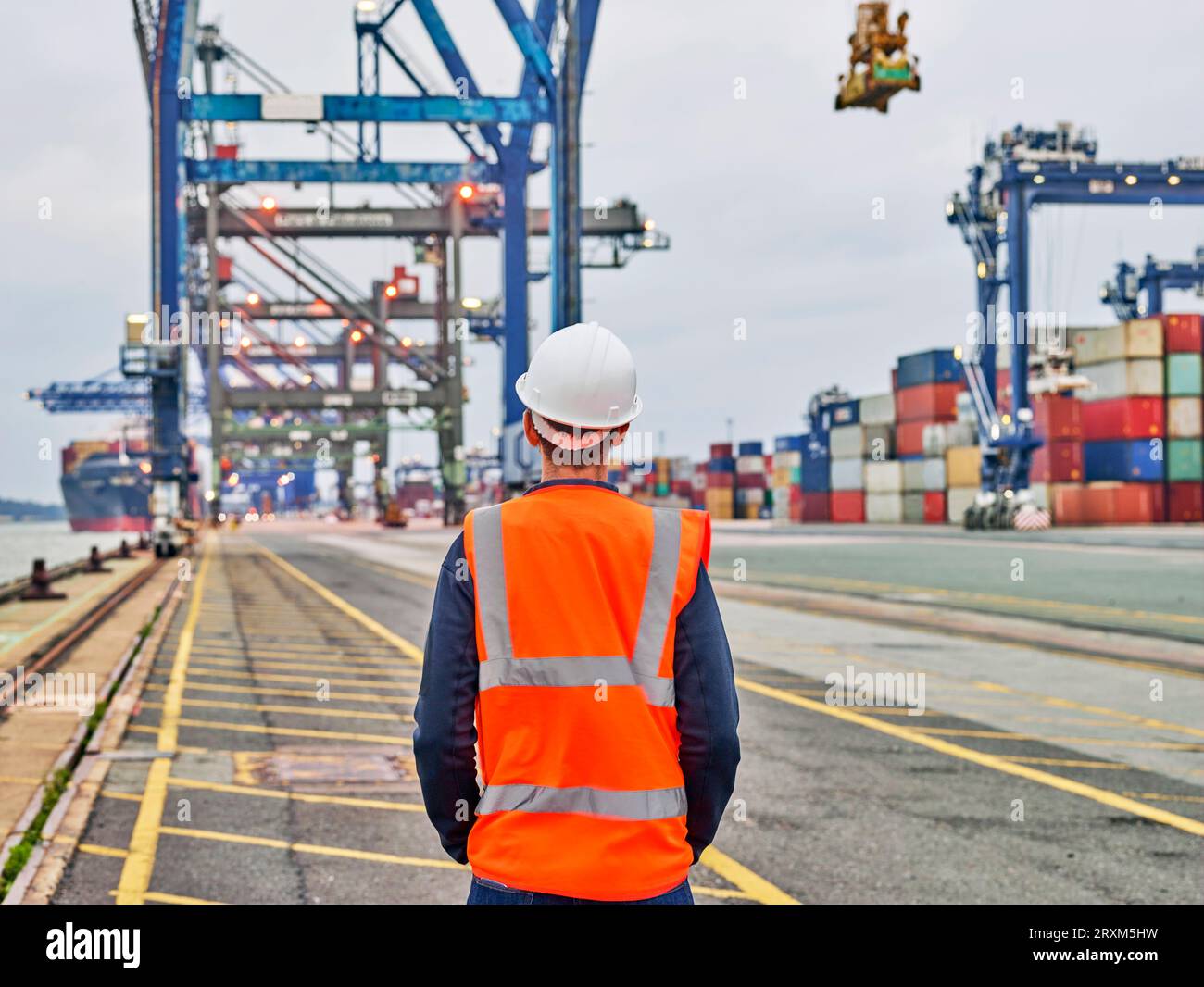 Rear view of dock worker at Port of Felixstowe, England Stock Photo - Alamy