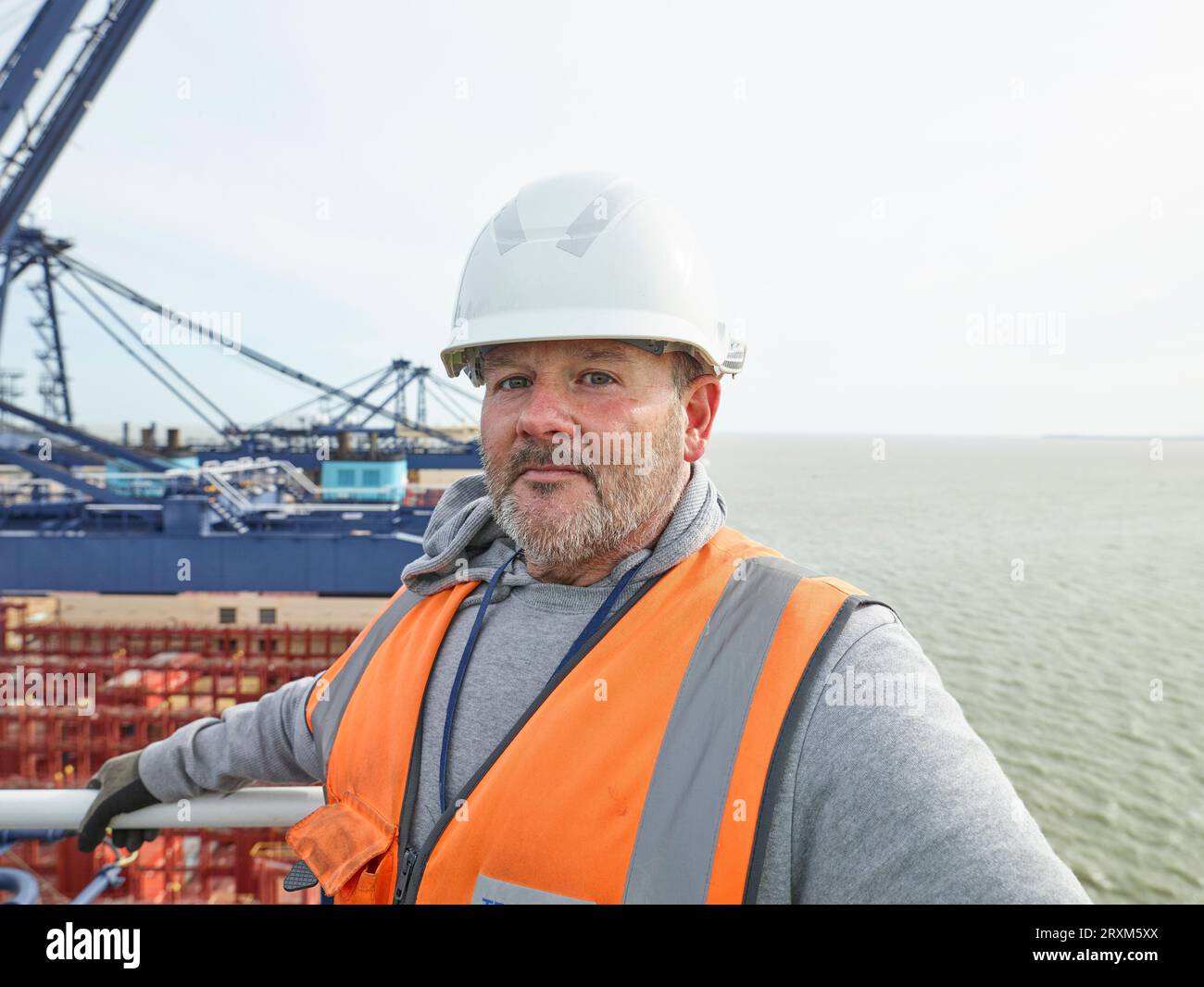 Dock worker with hard hat Stock Photo - Alamy