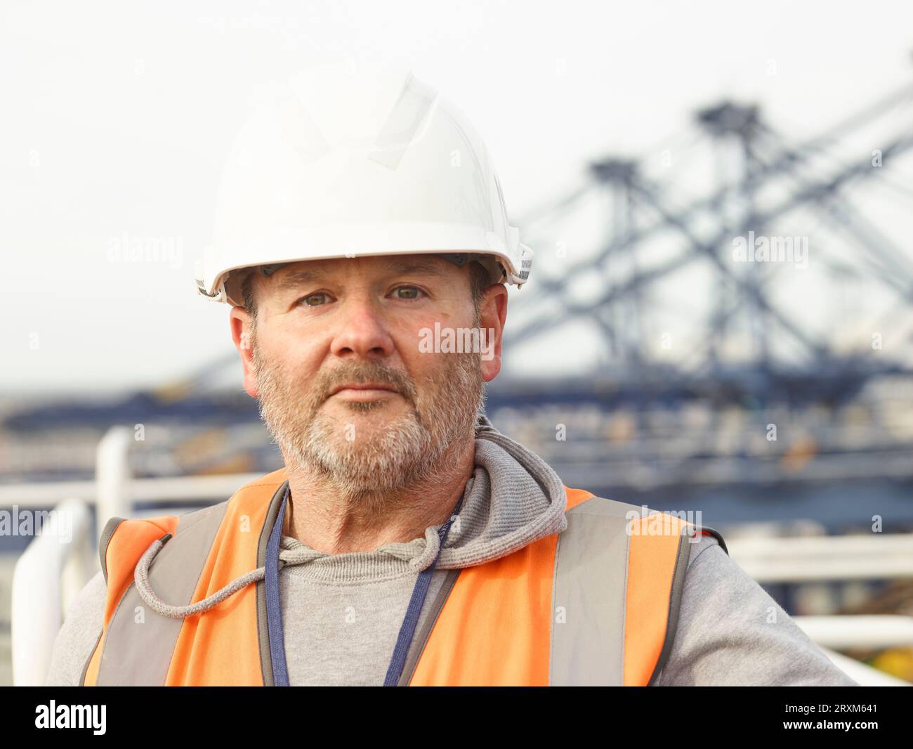 Dock worker with hard hat Stock Photo - Alamy
