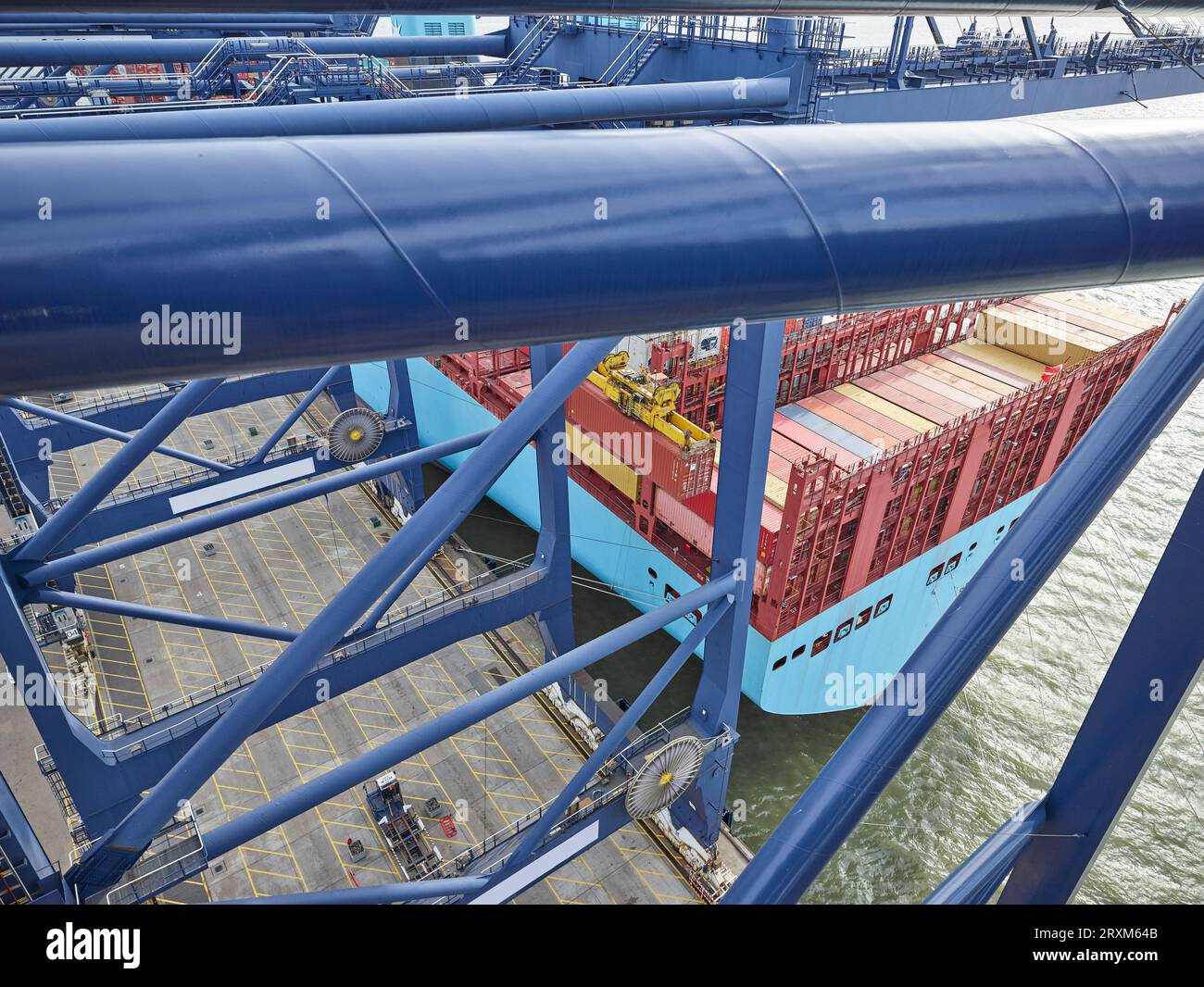 Dock crane above cargo ship Stock Photo - Alamy