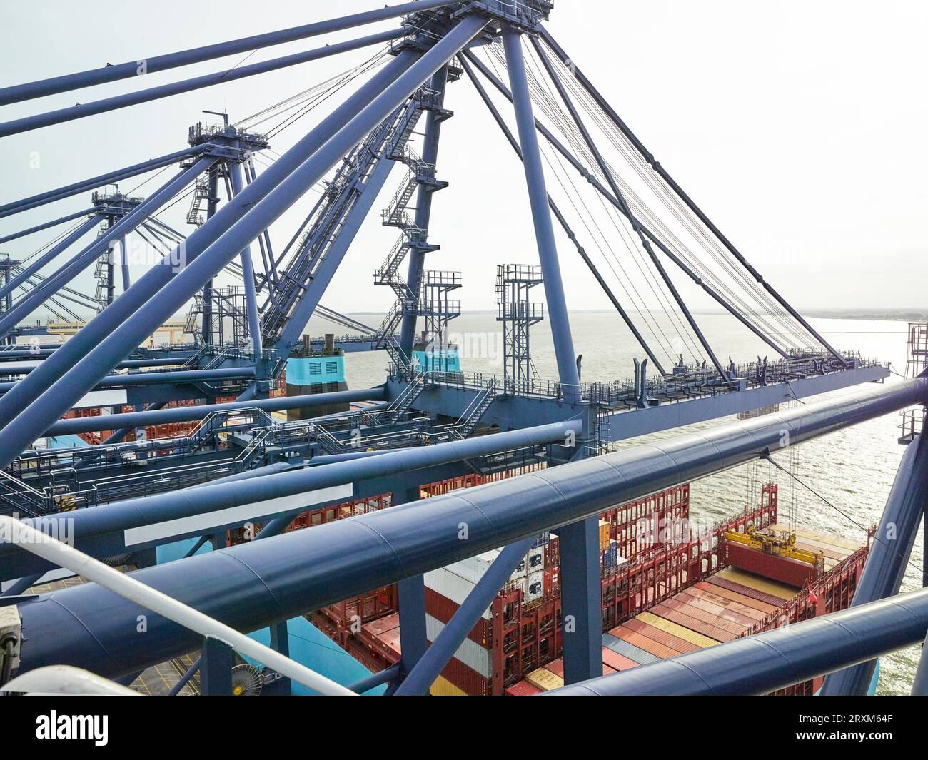 Dock crane above cargo ship Stock Photo - Alamy