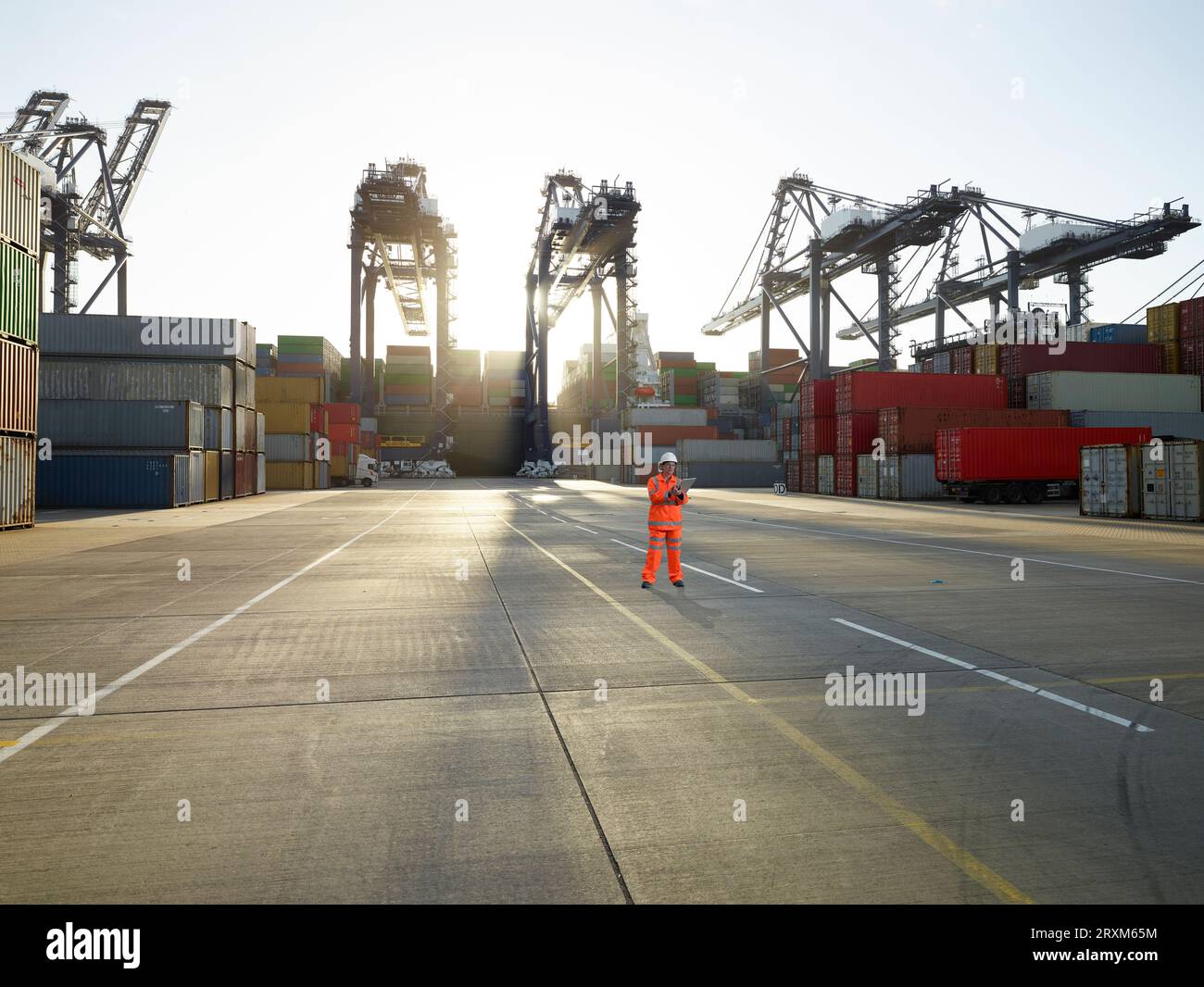 Dock worker with digital tablet Stock Photo - Alamy