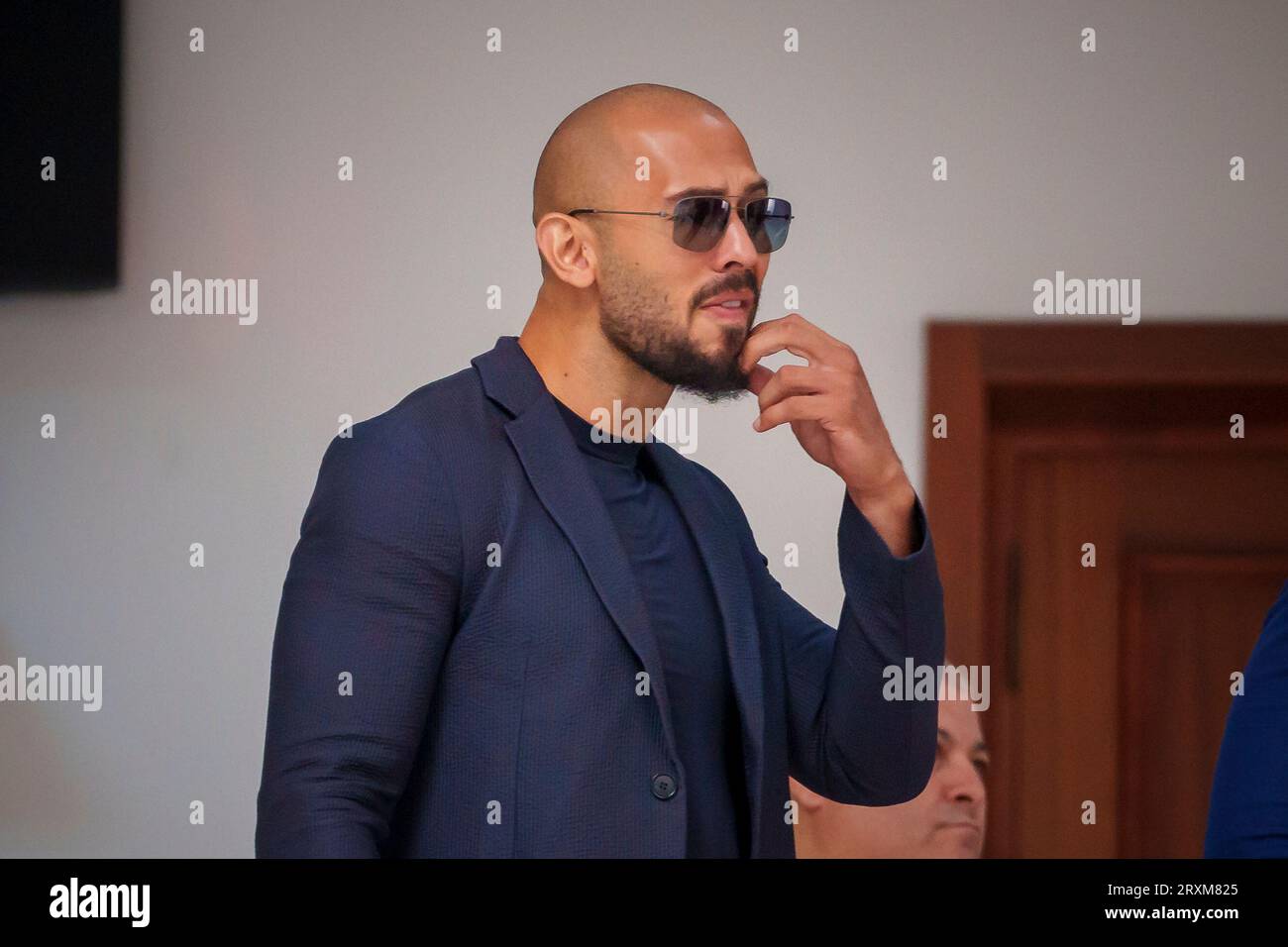 Andrew Tate touches his beard as he arrives at the Bucharest Tribunal ...