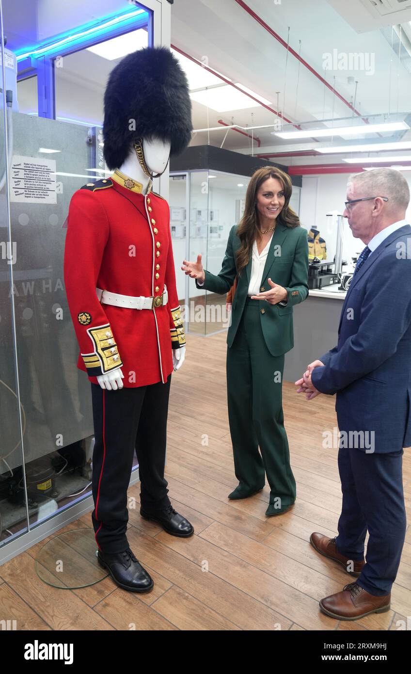 The Princess of Wales looks at a Guardsmans scarlet tunic during a ...