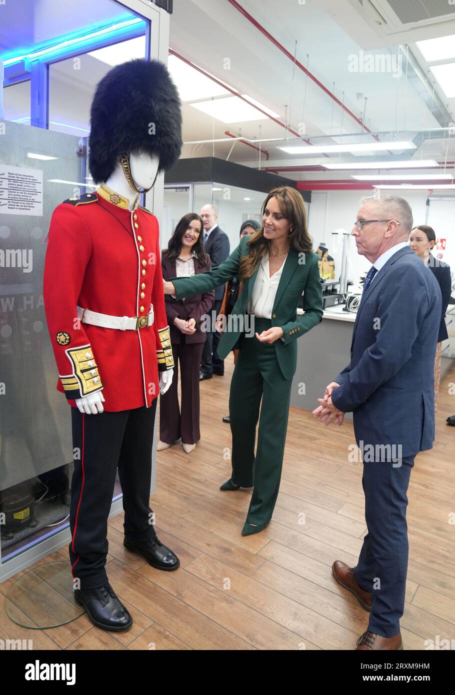 The Princess of Wales looks at a Guardsmans scarlet tunic during a ...
